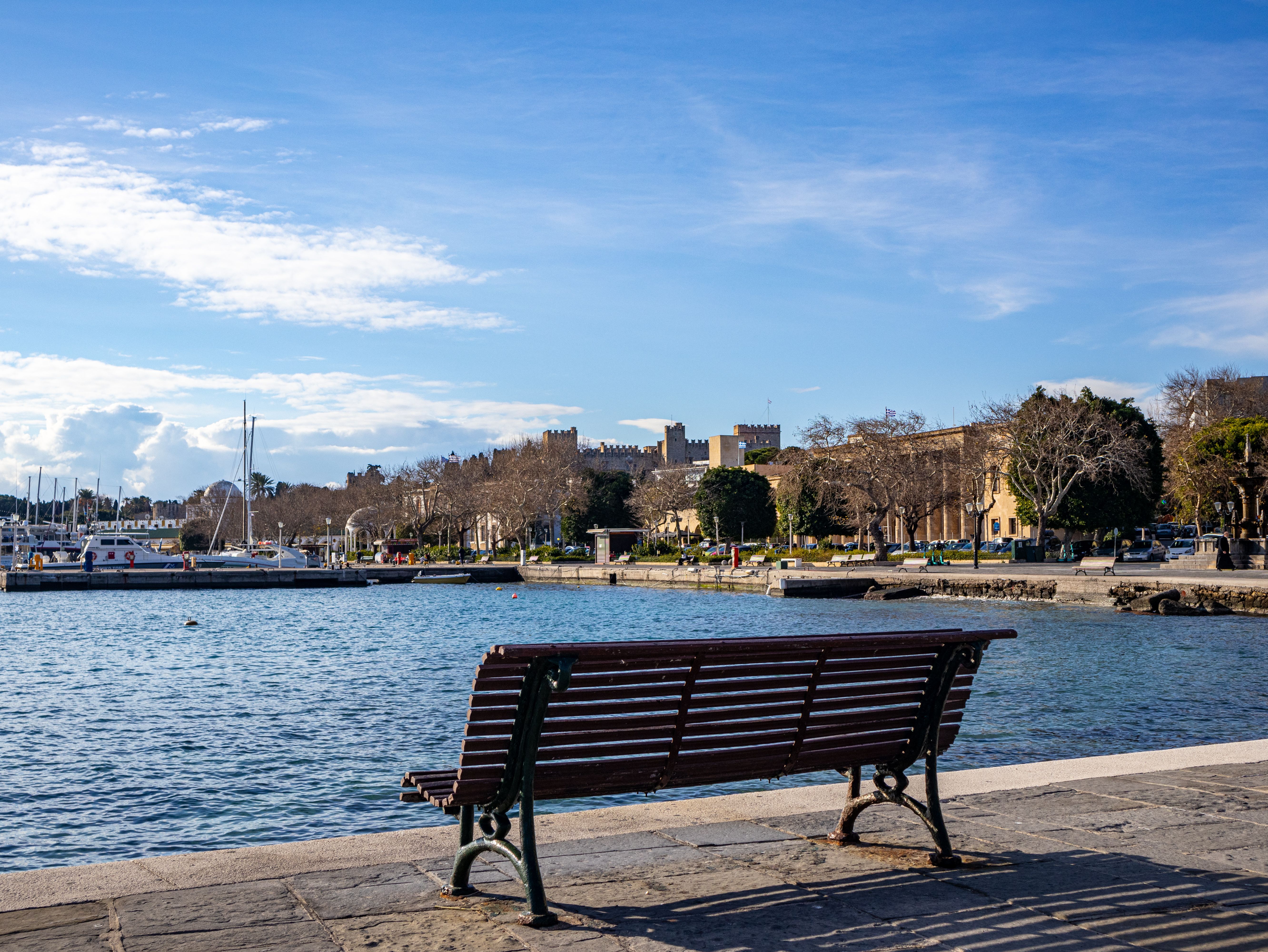 Scenic Waterfront with Bench and Marina View · Free Stock Photo