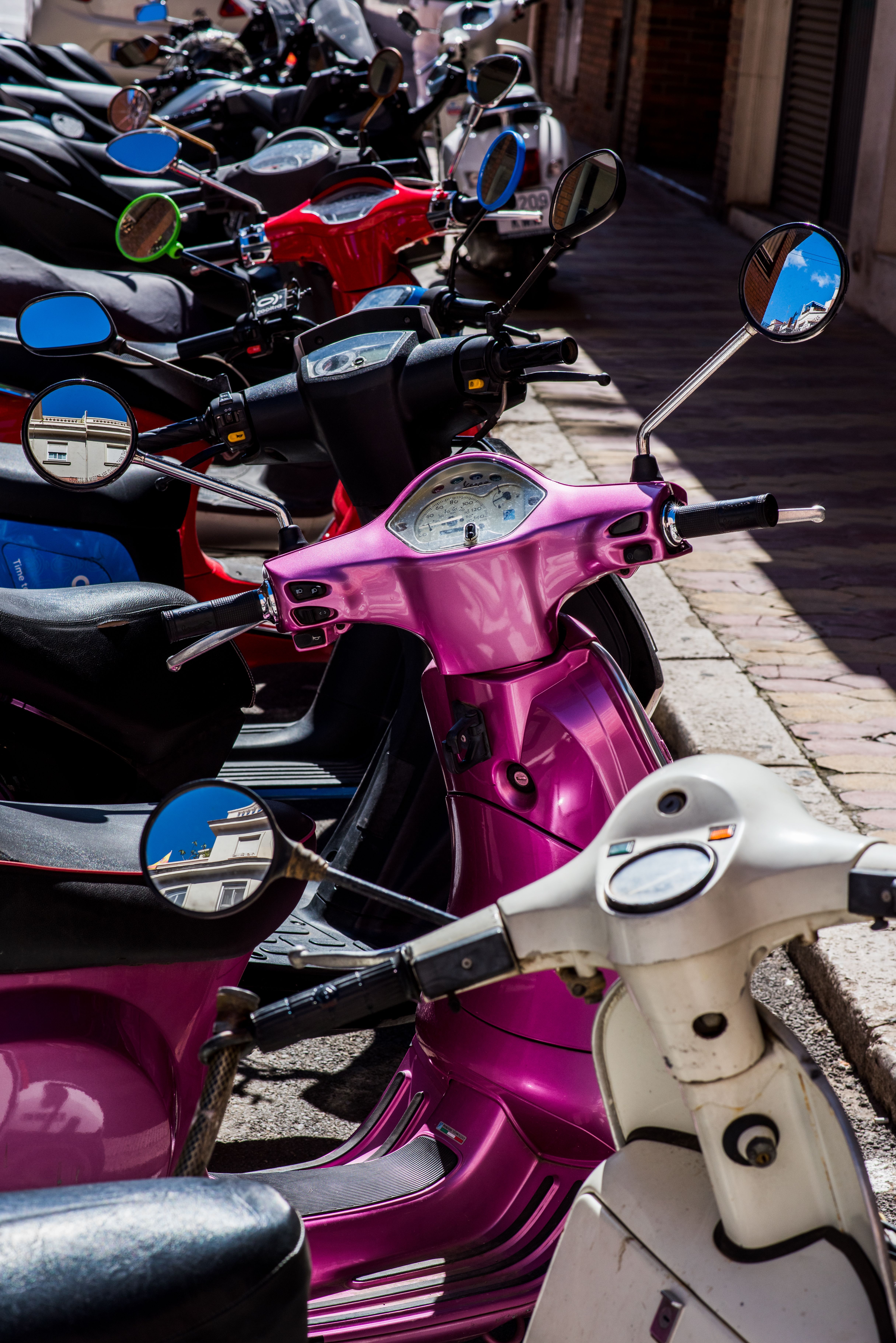 Colorful scooters parked in urban street · Free Stock Photo