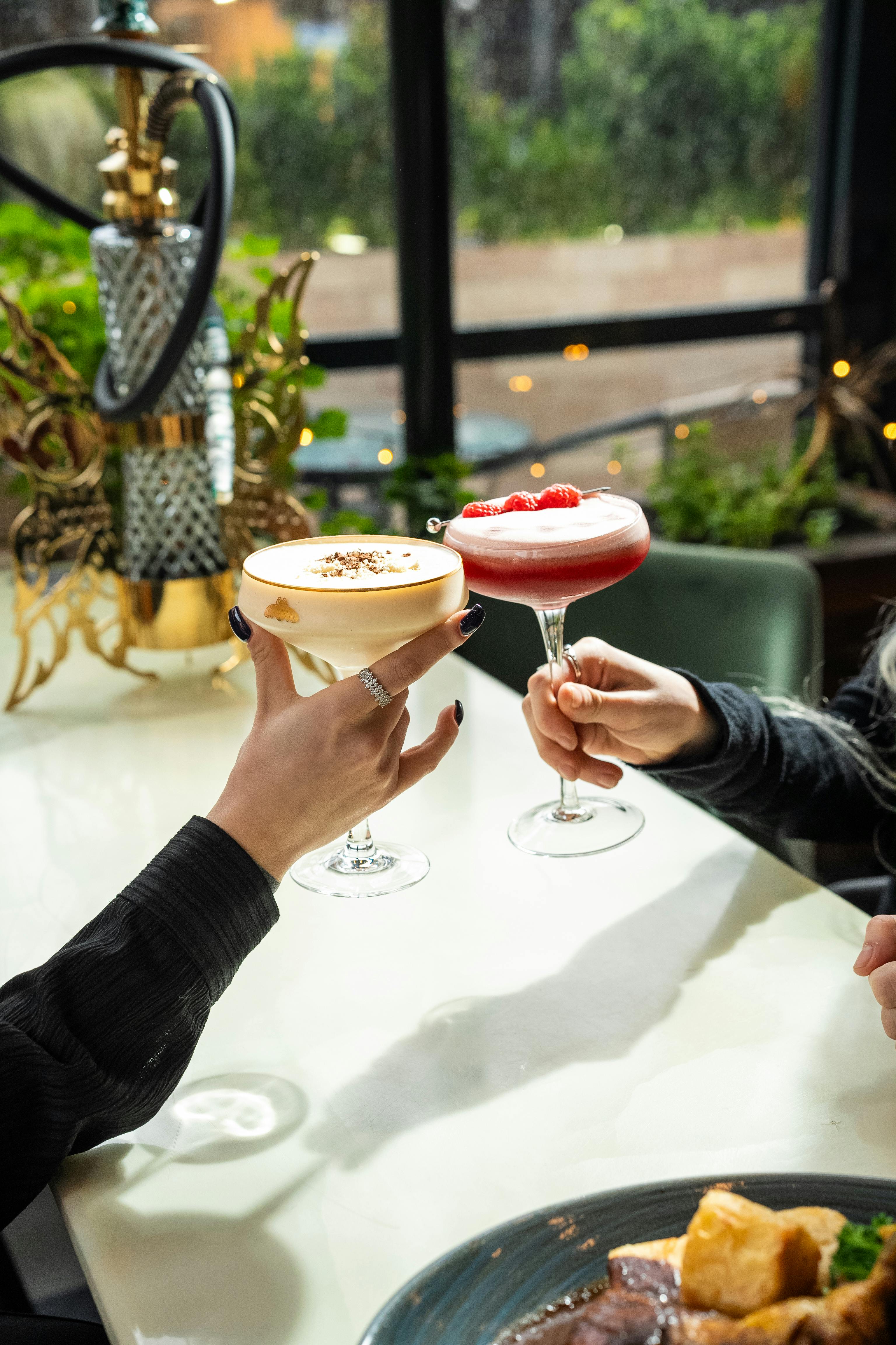 Elegant Cocktail Toast in a Stylish Lounge Setting · Free Stock Photo