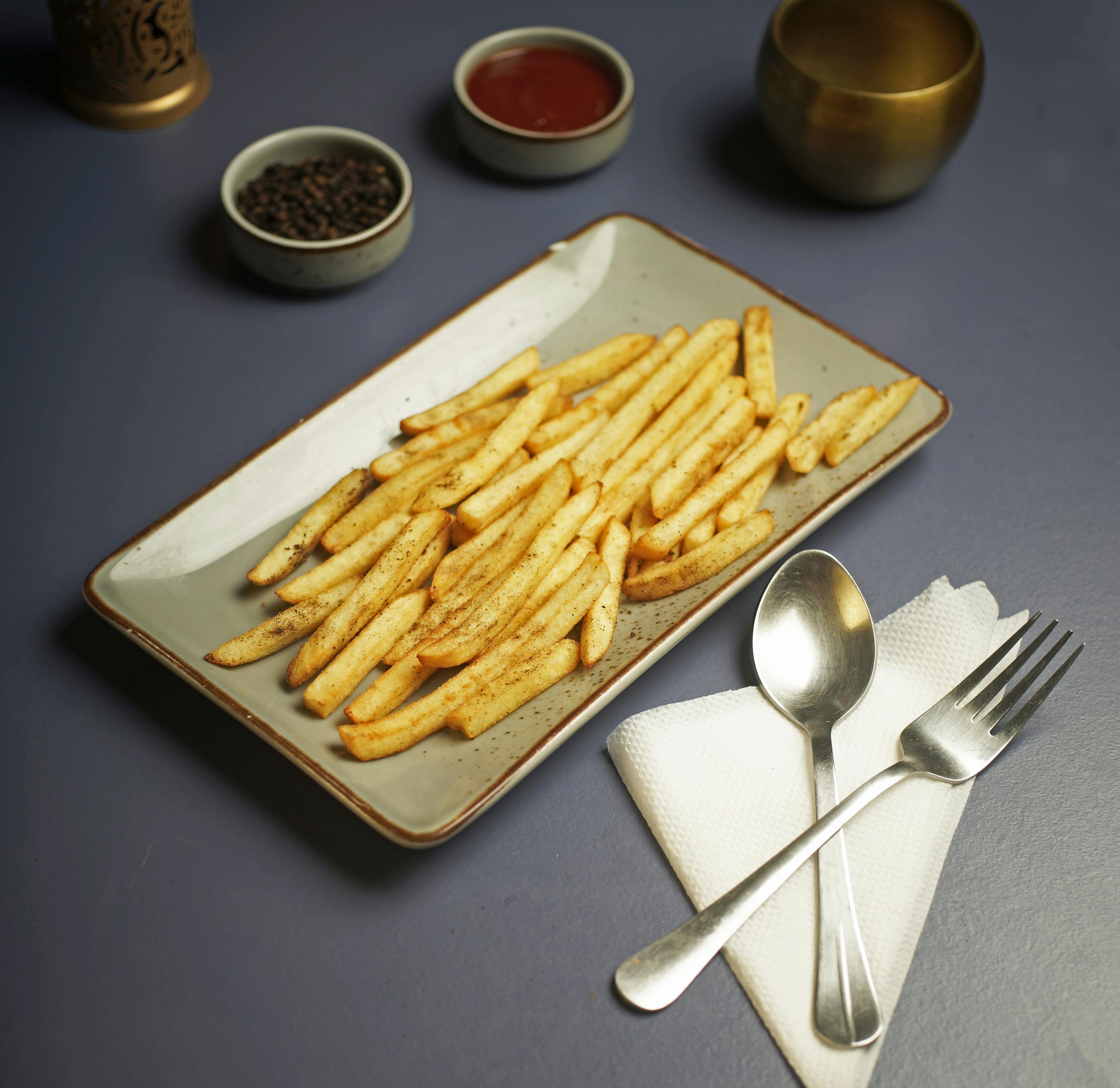 Crispy French Fries on Elegant Dining Setup · Free Stock Photo