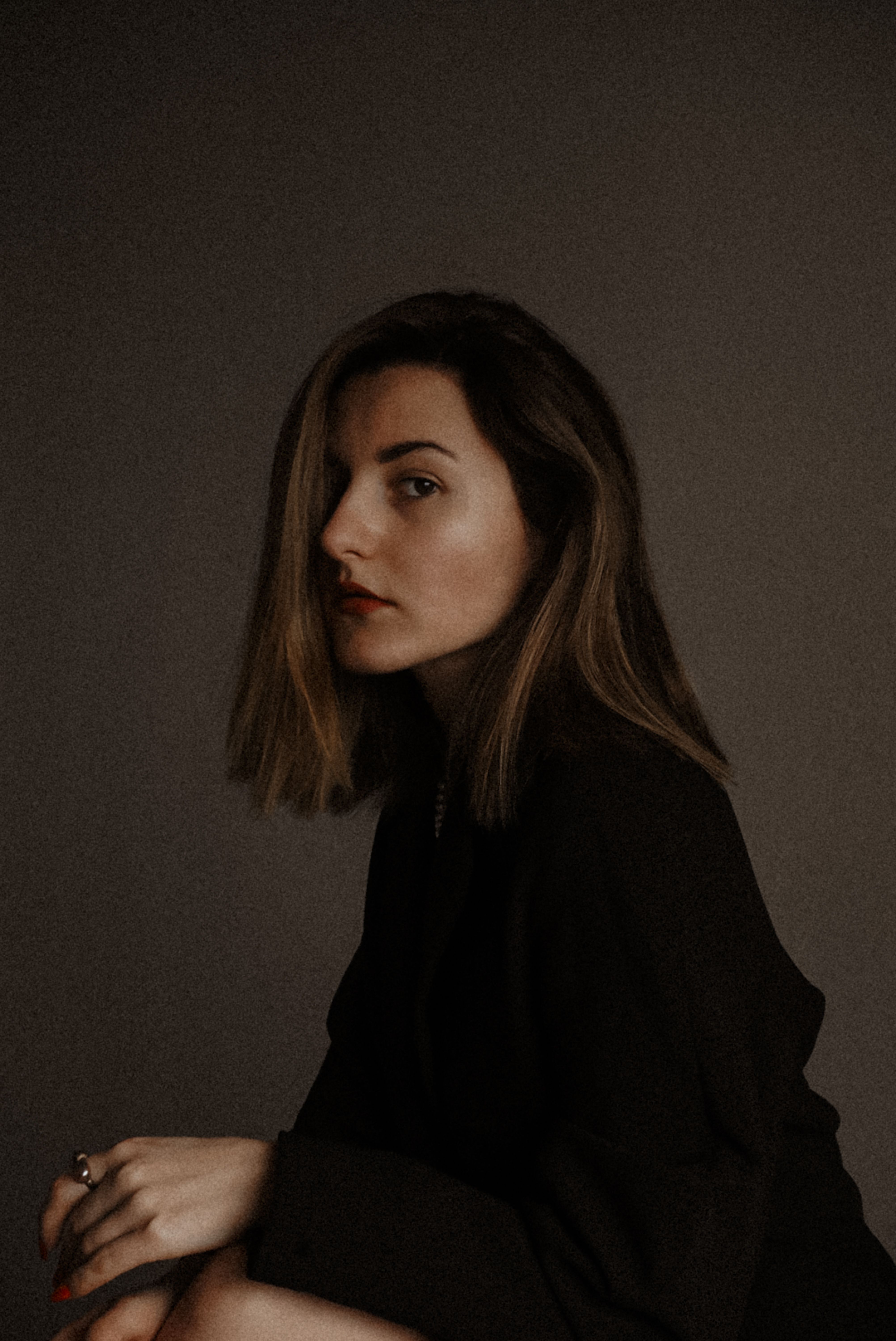 Moody Portrait of a Woman in Dim Lighting · Free Stock Photo