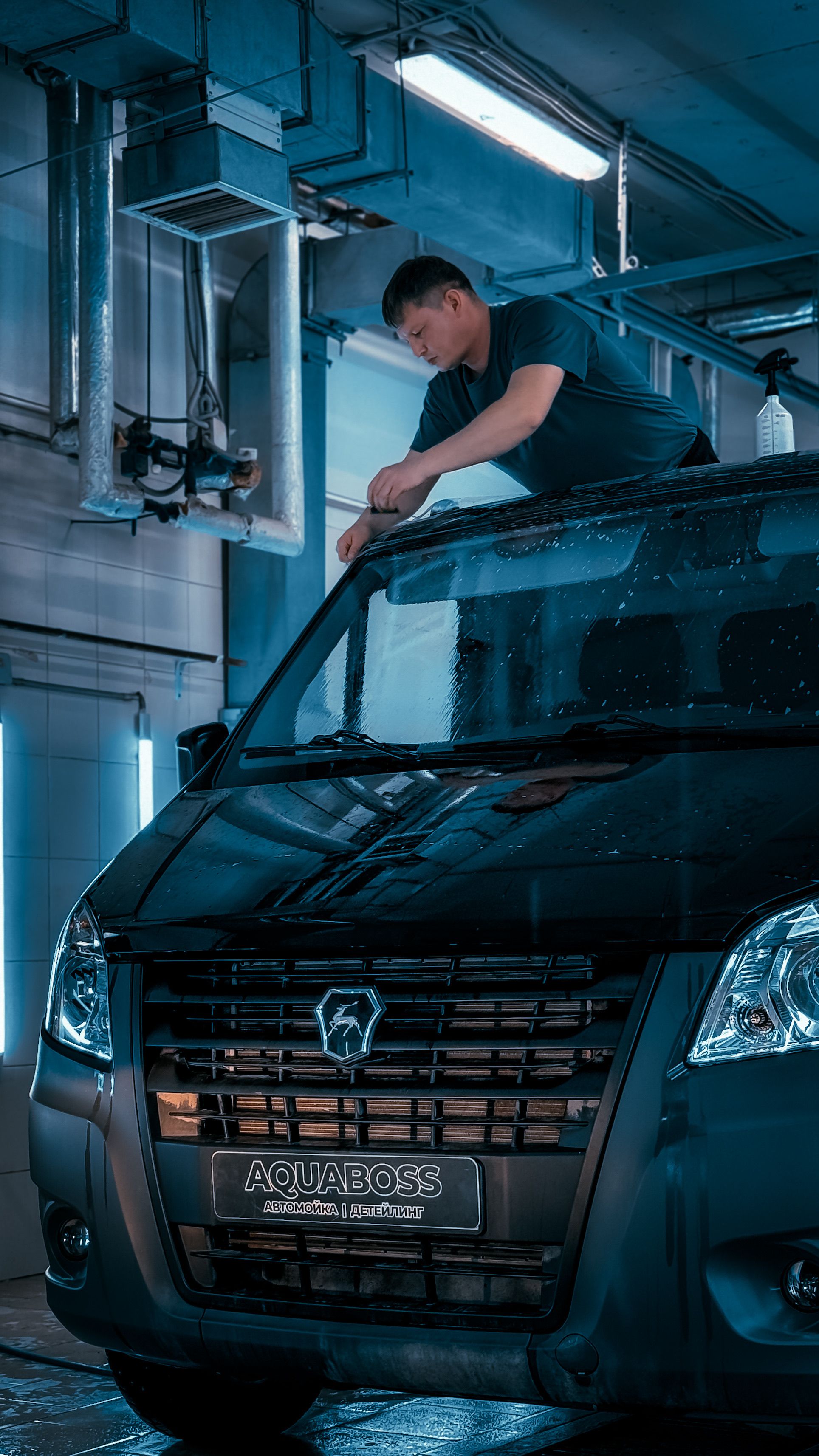 Man Washing Van in Indoor Car Wash Facility · Free Stock Photo