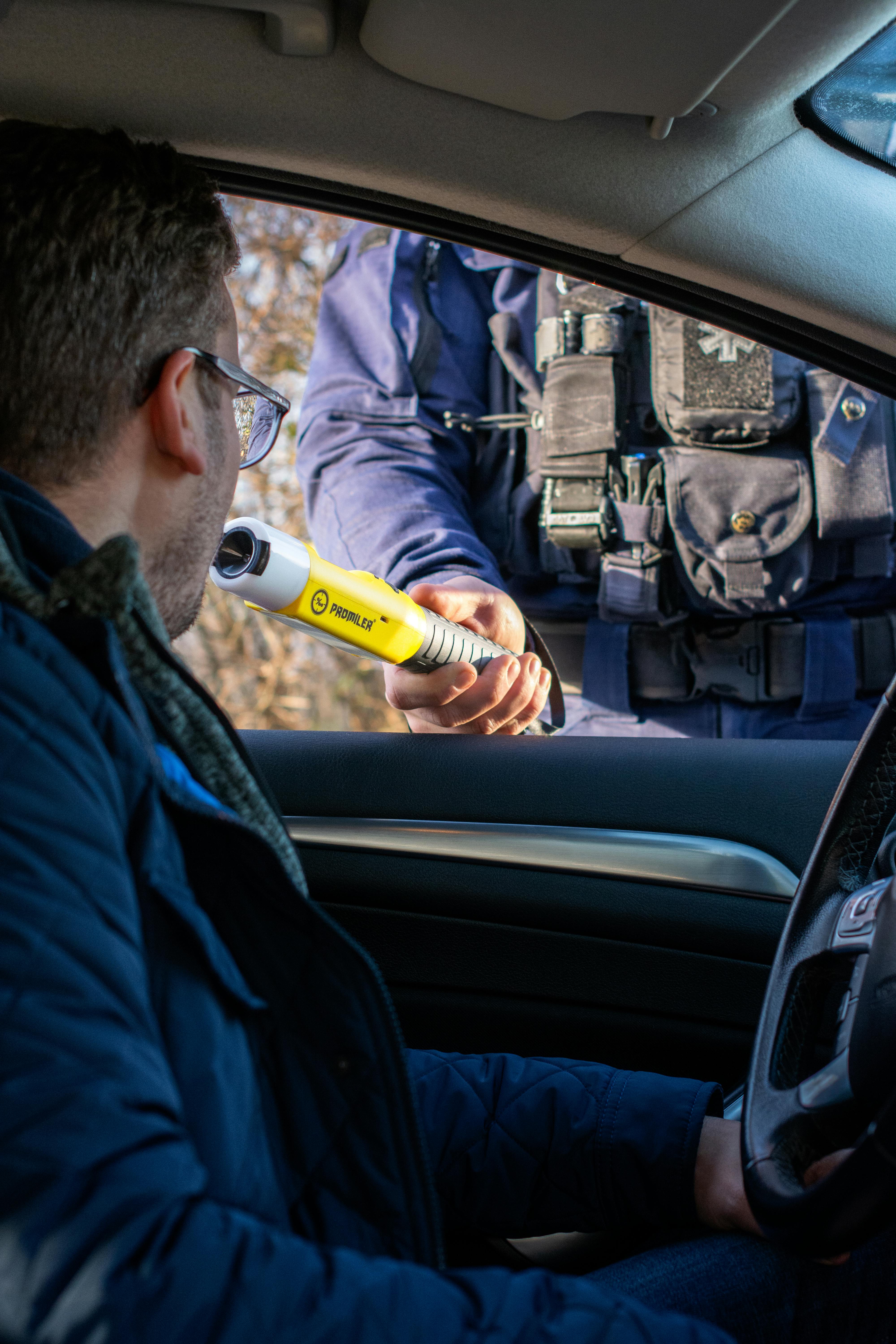 Police Officer Conducting a Breathalyzer Test · Free Stock Photo