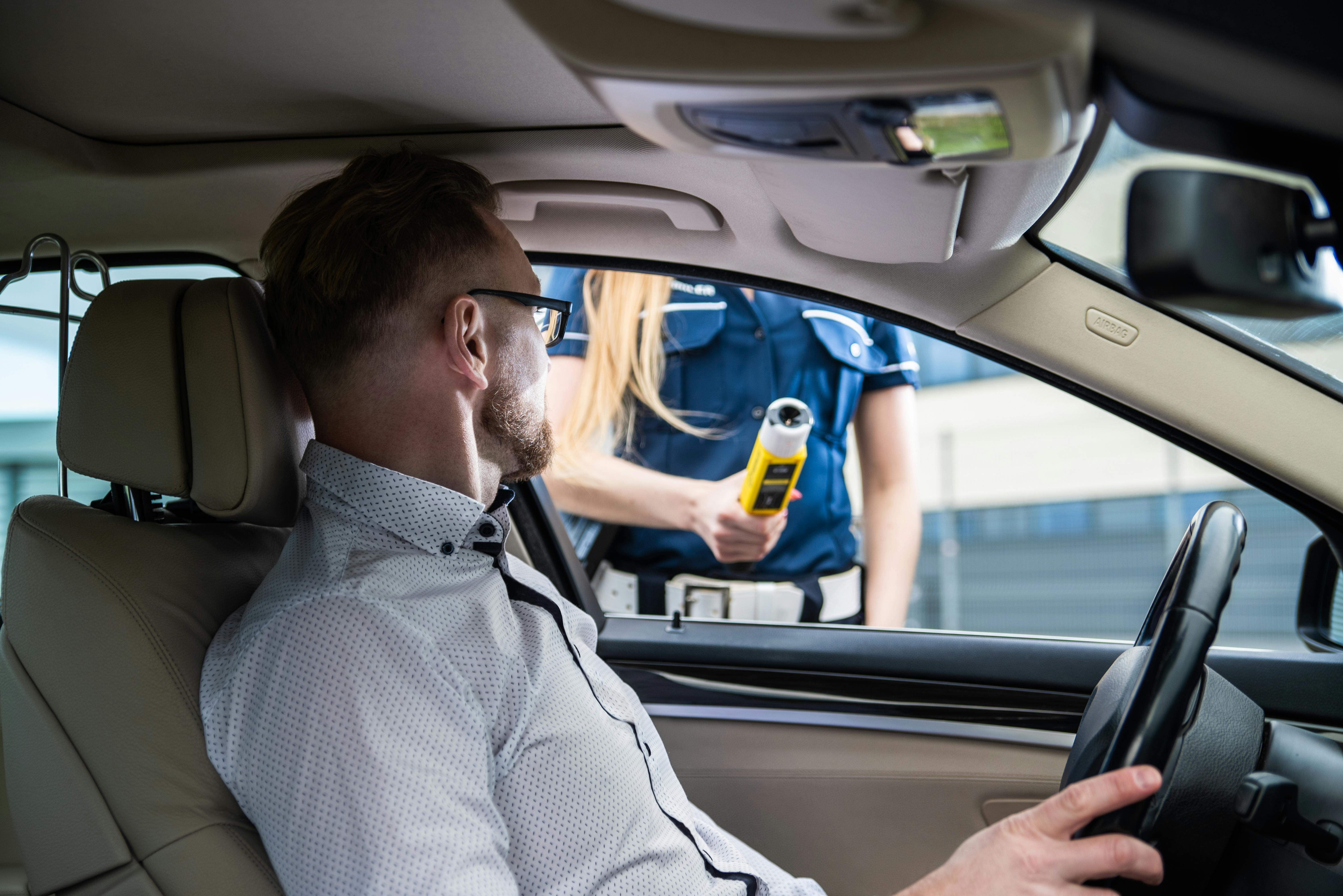 Police Officer Conducts Breathalyzer Test on Driver · Free Stock Photo