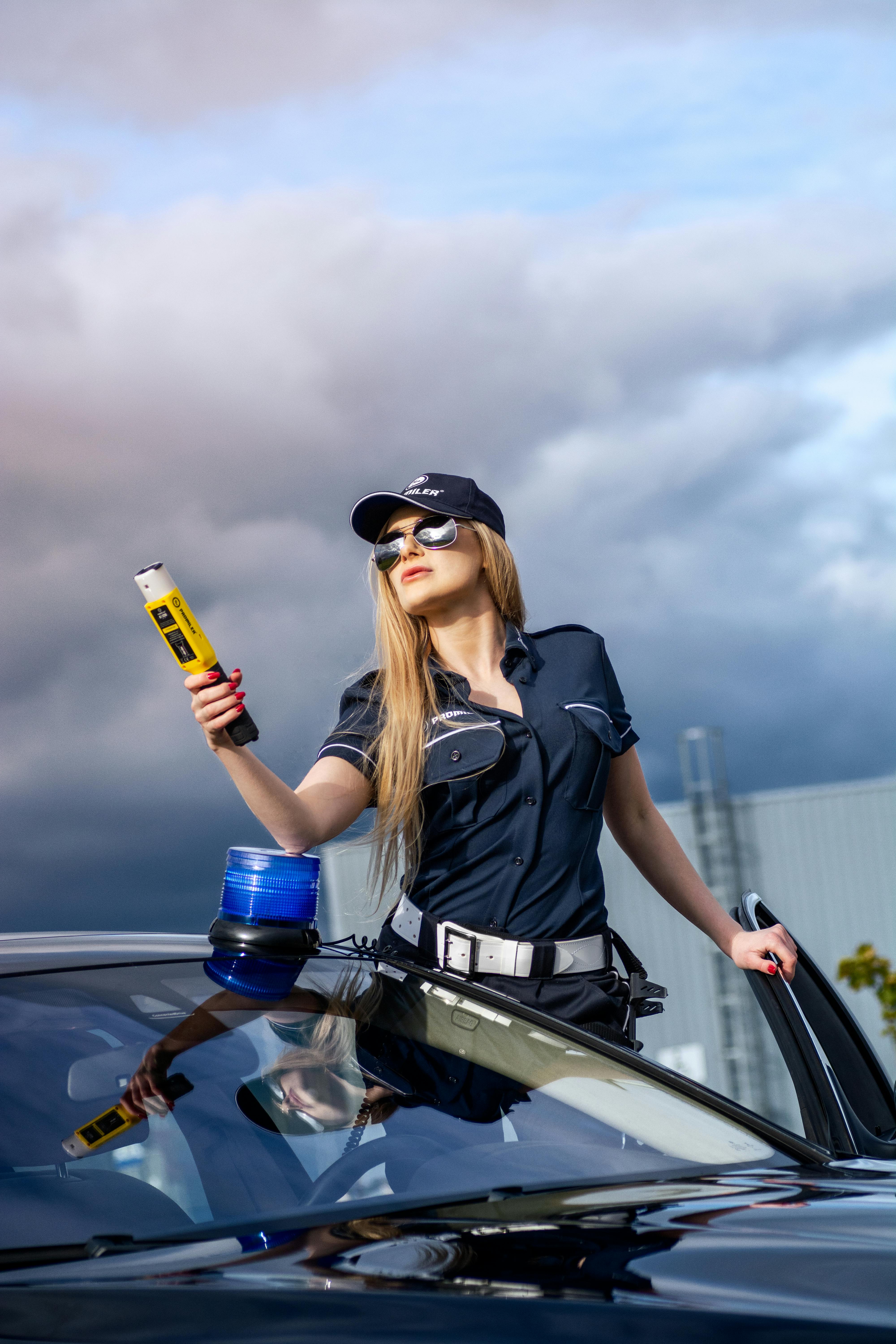 Female Police Officer Using Breathalyzer for Safety Control · Free ...