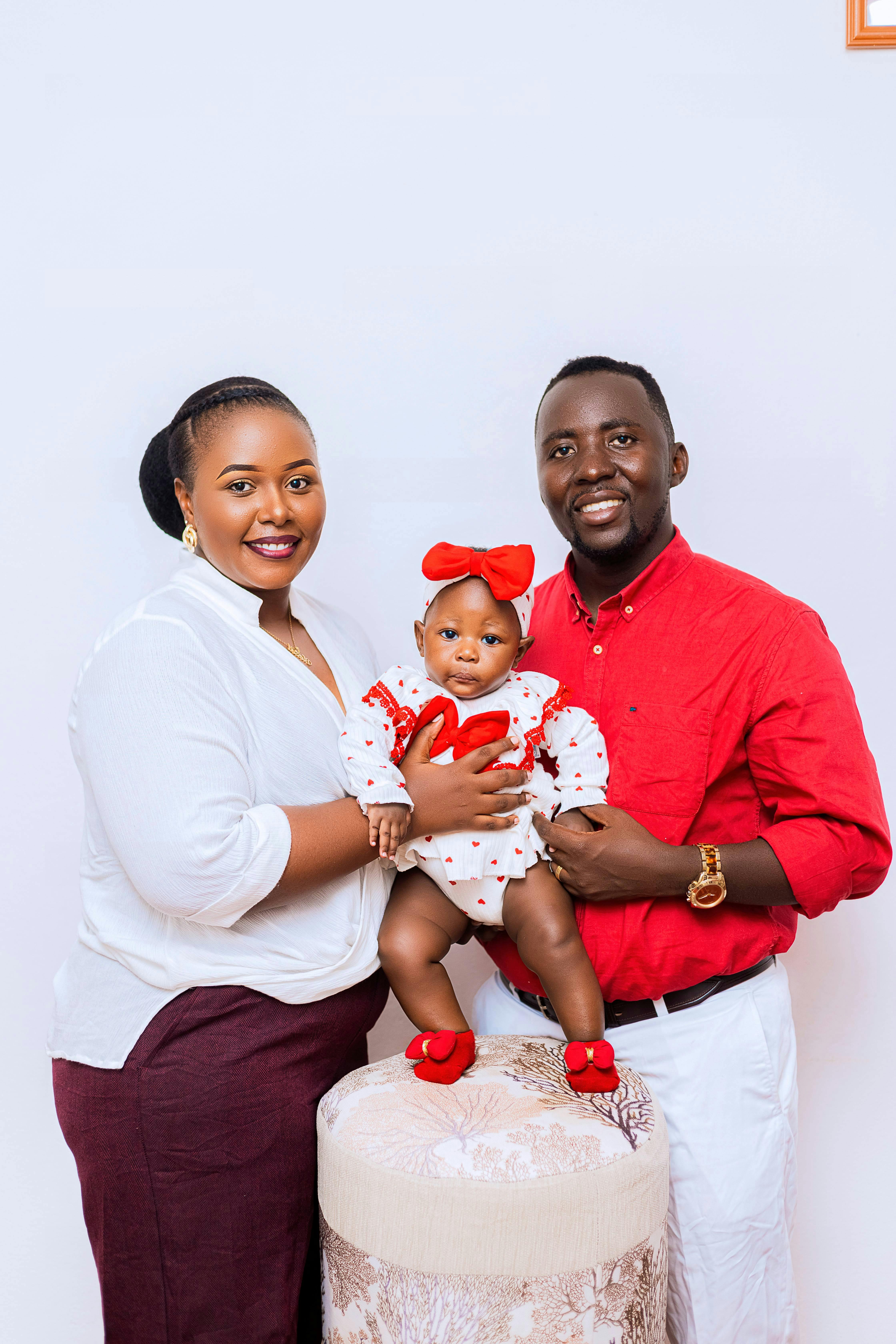 Happy Family Portrait with Baby in Red · Free Stock Photo
