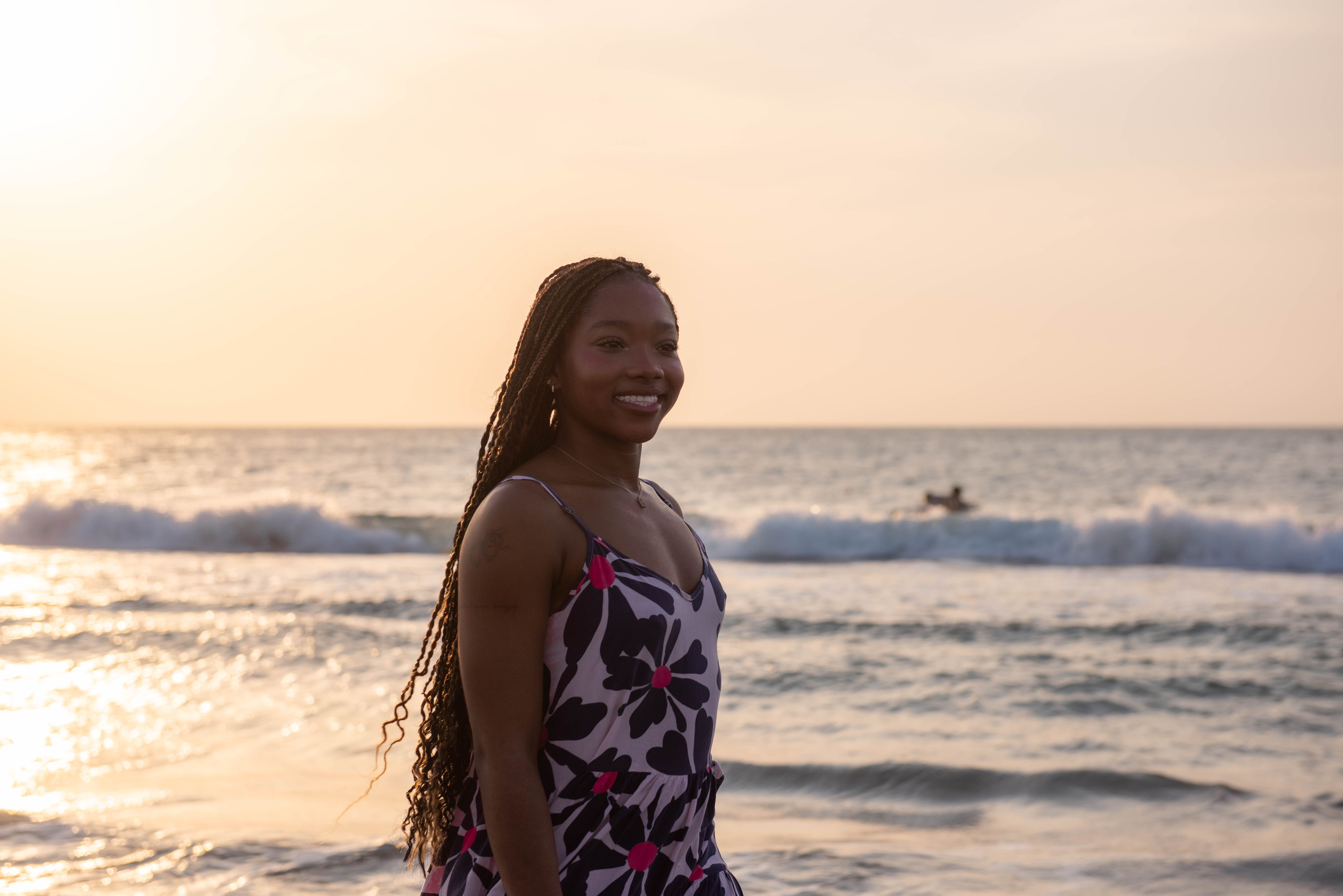 Smiling Woman on a Sunset Beach · Free Stock Photo
