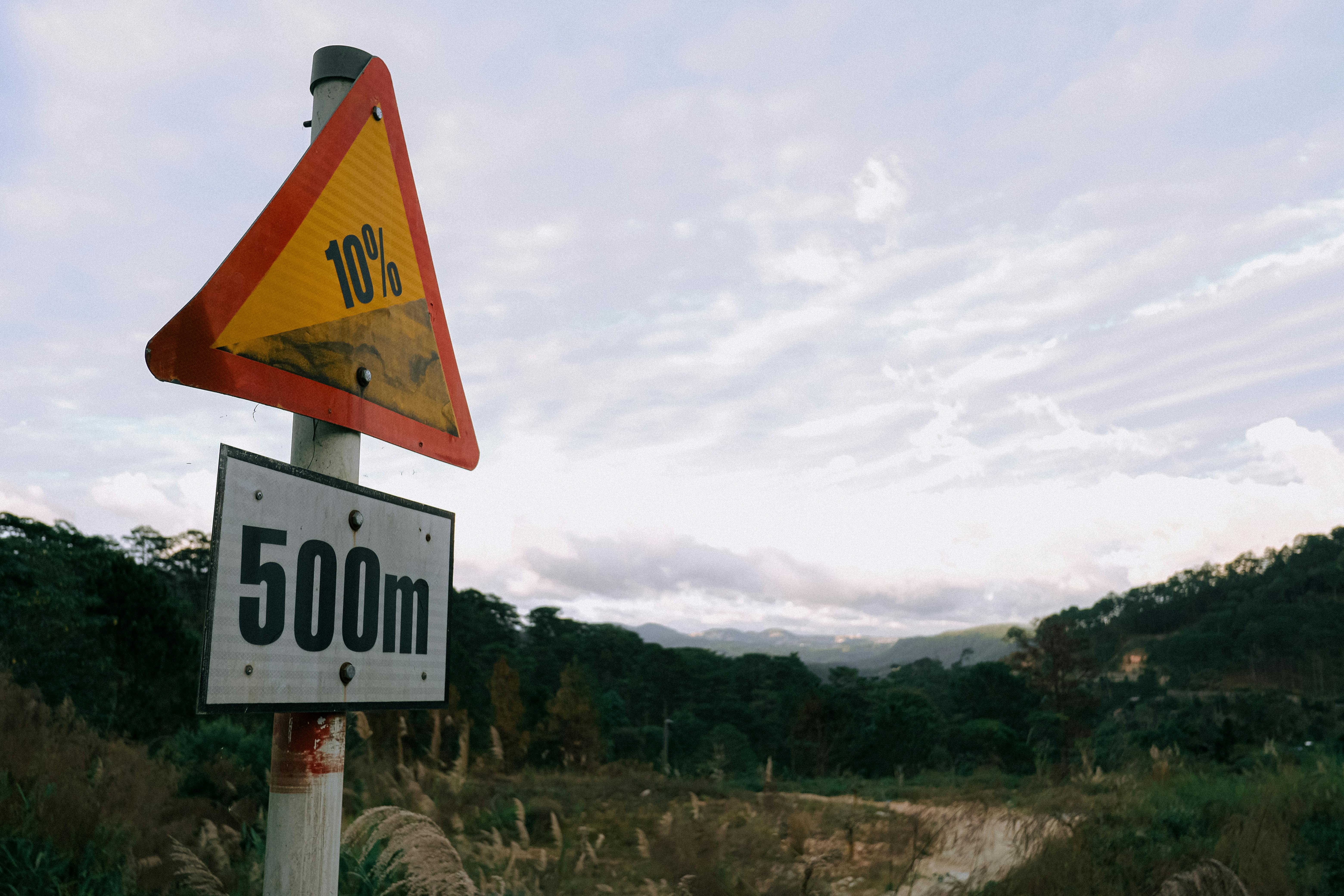 Scenic Road Sign in Hilly Landscape · Free Stock Photo