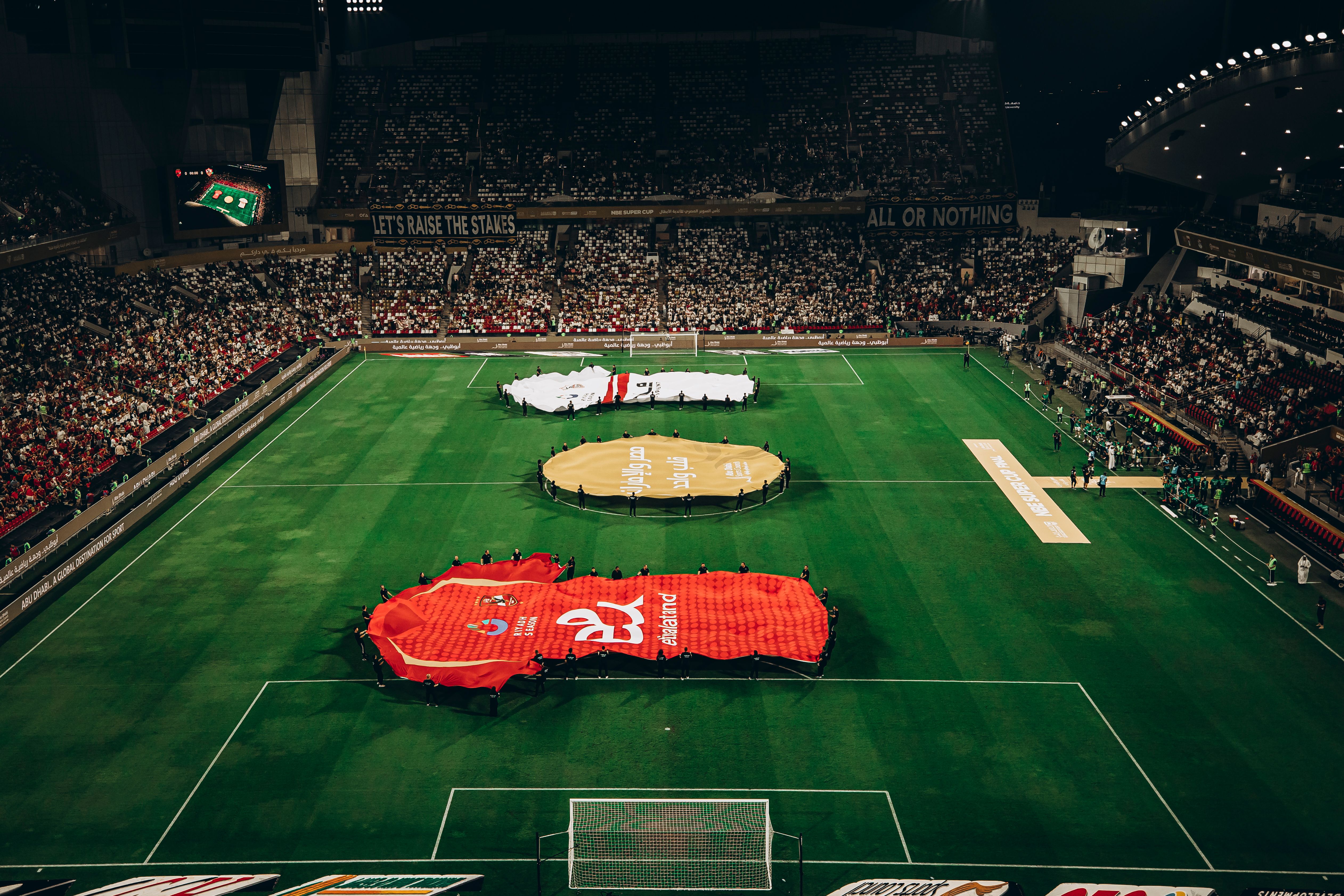 Exciting Night Football Match in a Packed Stadium · Free Stock Photo