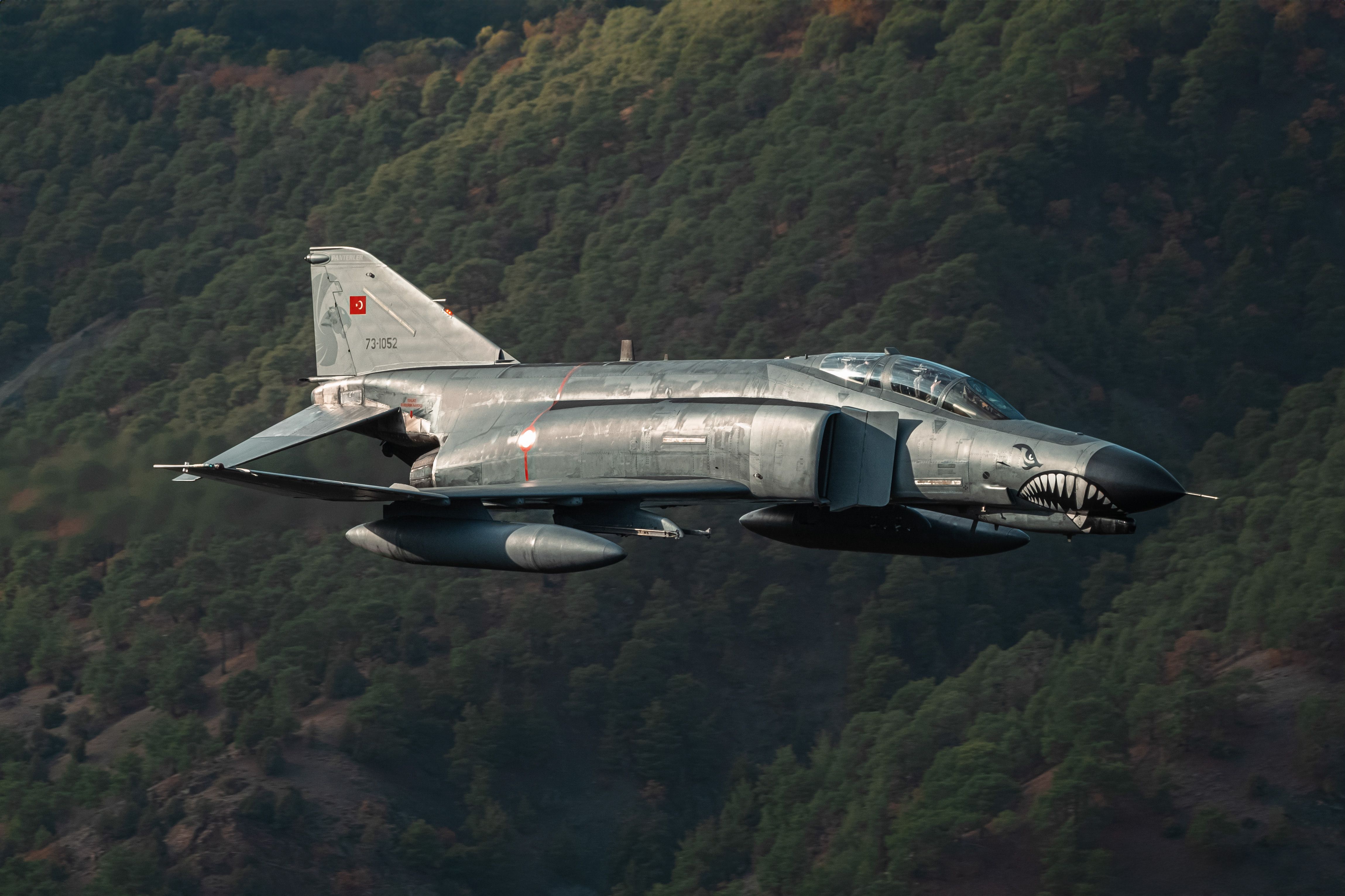 Turkish Air Force Jet Flying Over Forested Terrain · Free Stock Photo