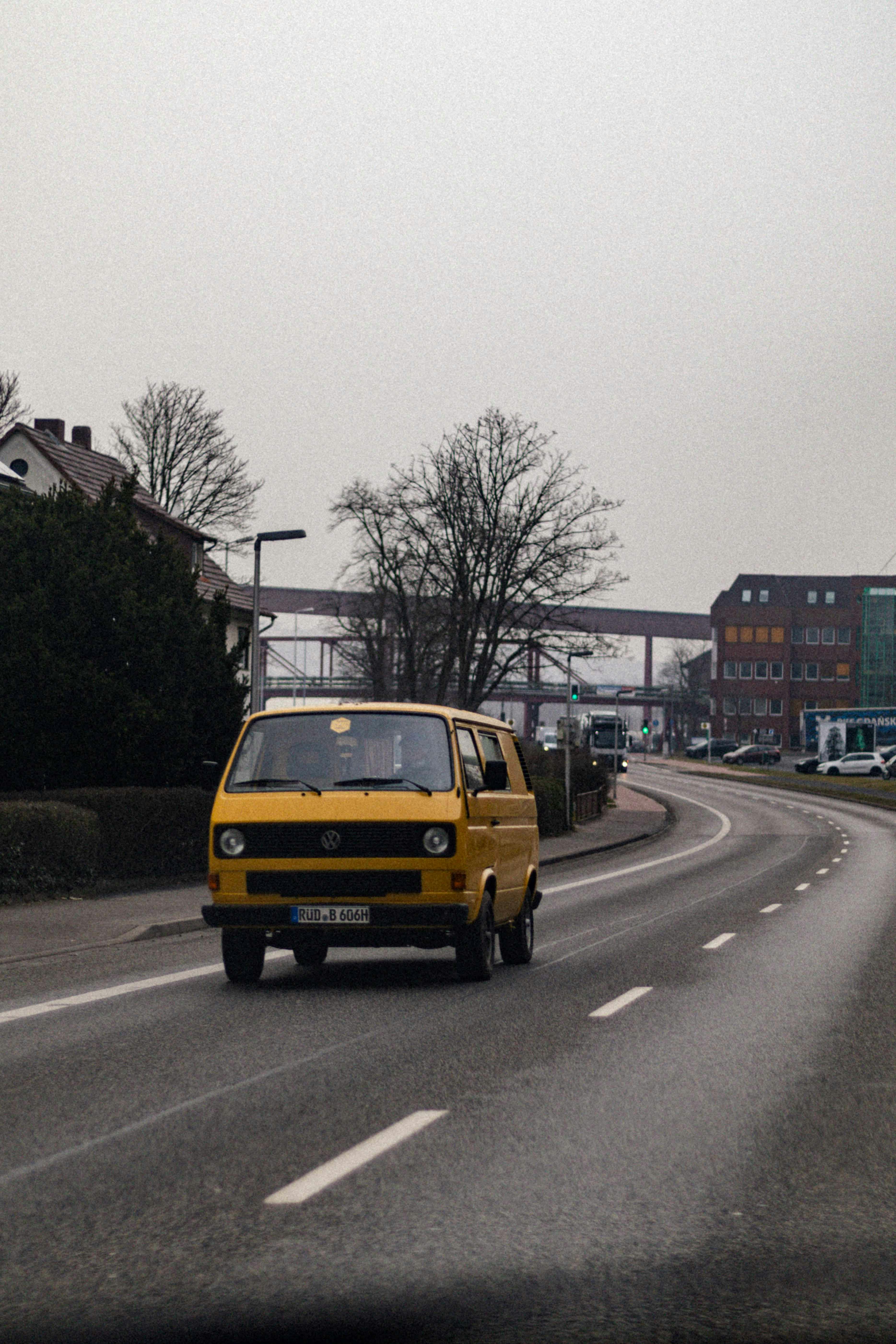 Vintage Yellow Van on Urban Street in Overcast Weather · Free Stock Photo