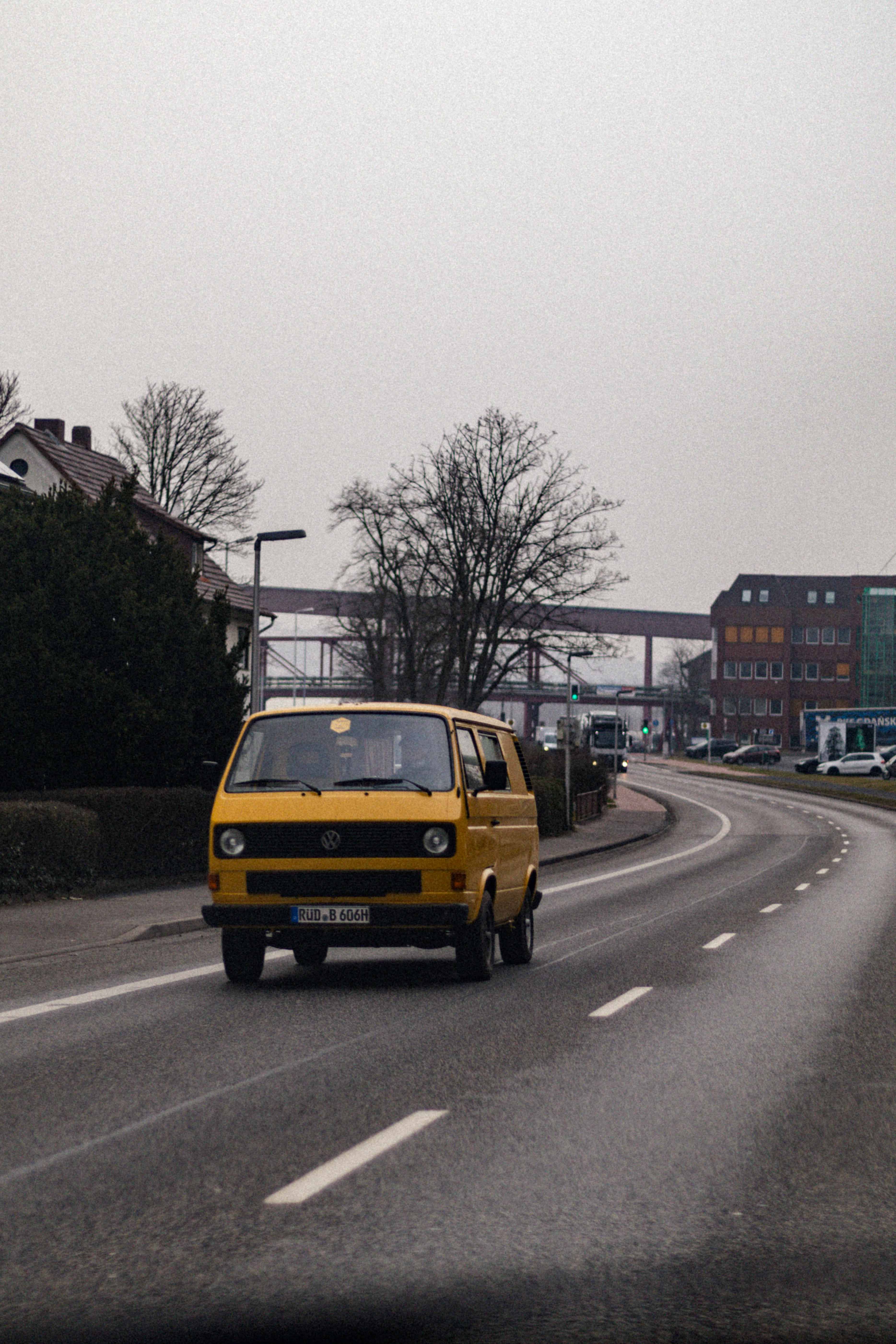 Vintage Yellow Van on Urban Street in Overcast Weather · Free Stock Photo