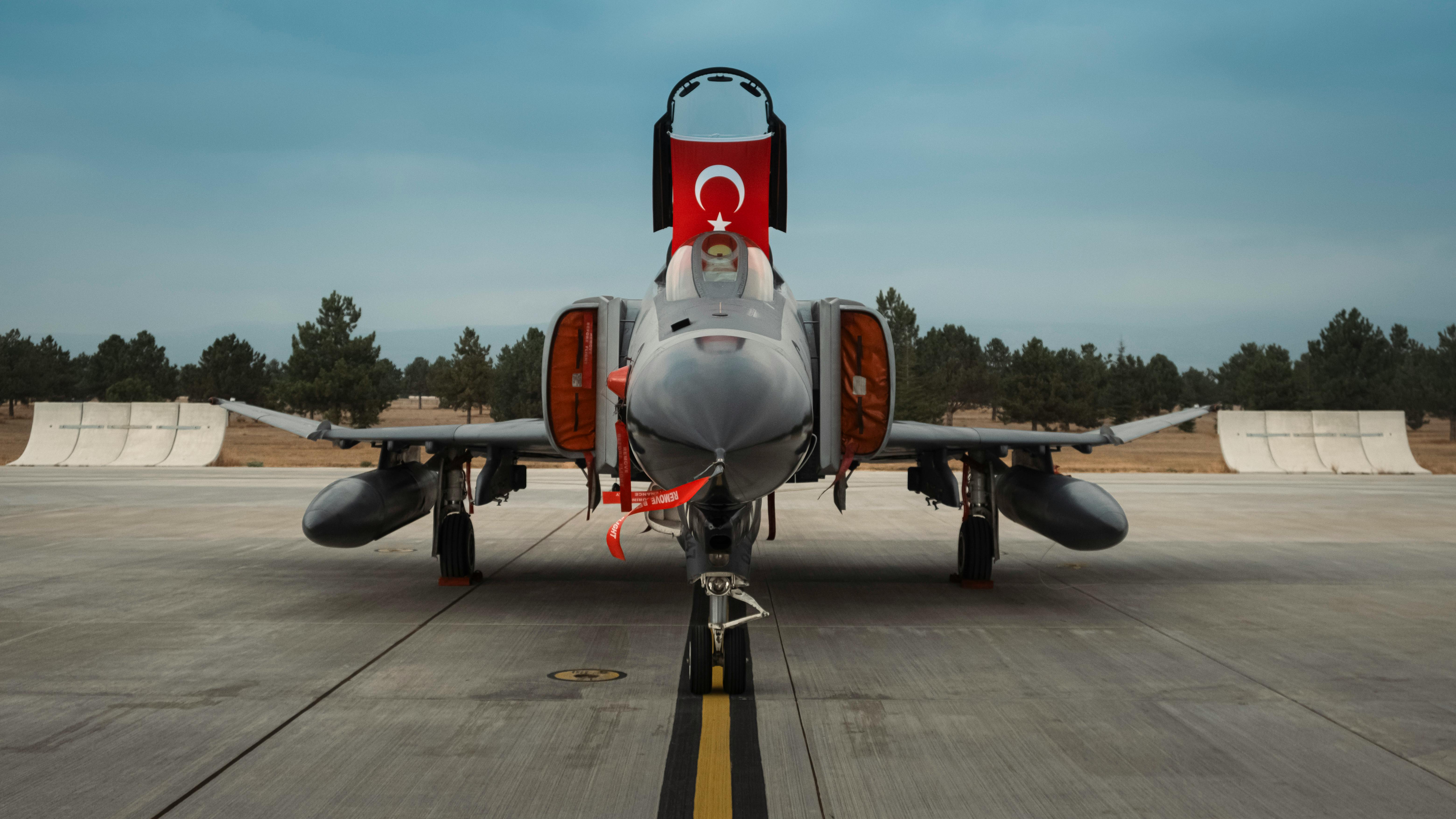 Turkish Jet Fighter on Runway with Flag Displayed · Free Stock Photo