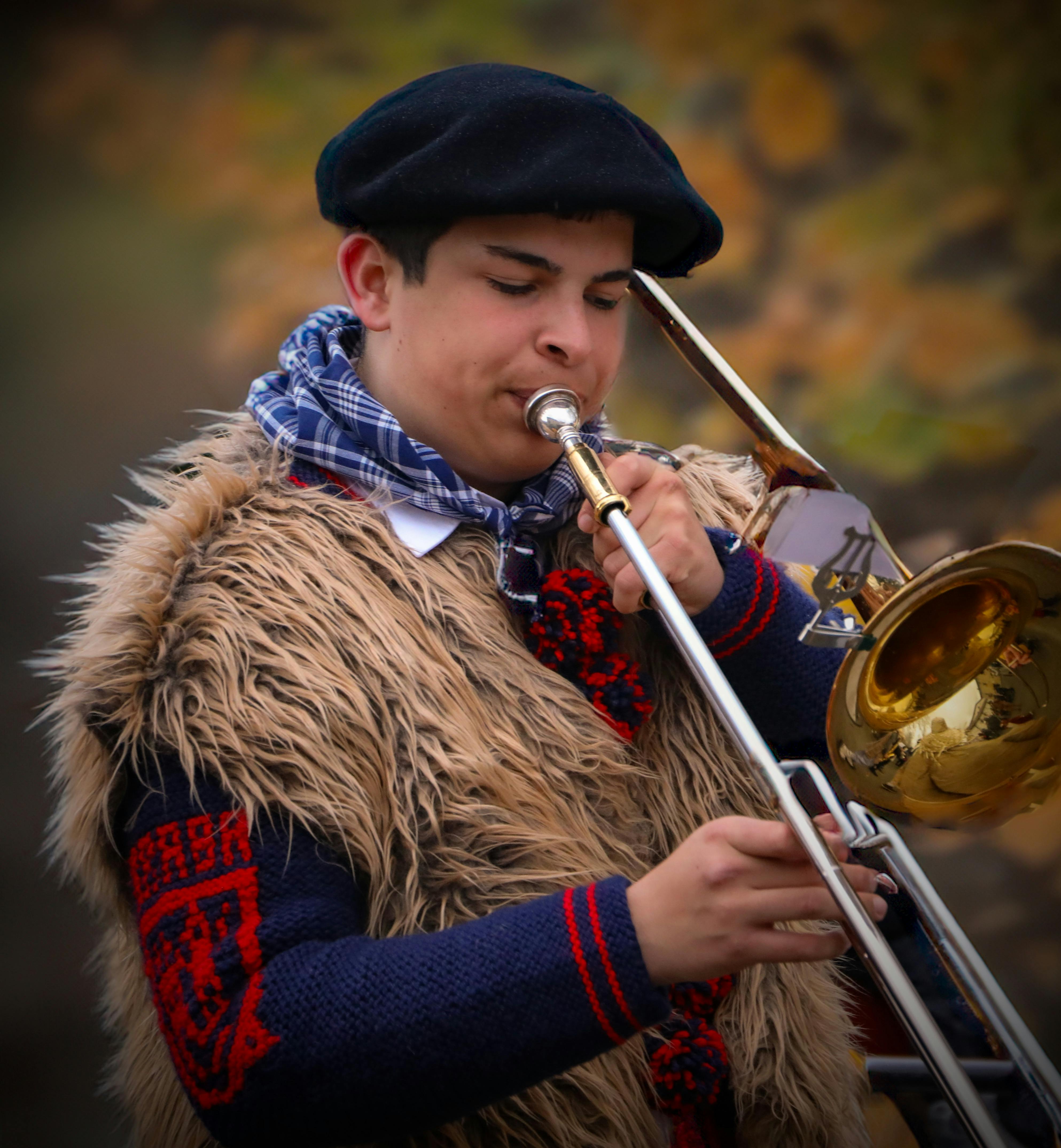 Traditional Musician Playing Trombone Outdoors · Free Stock Photo
