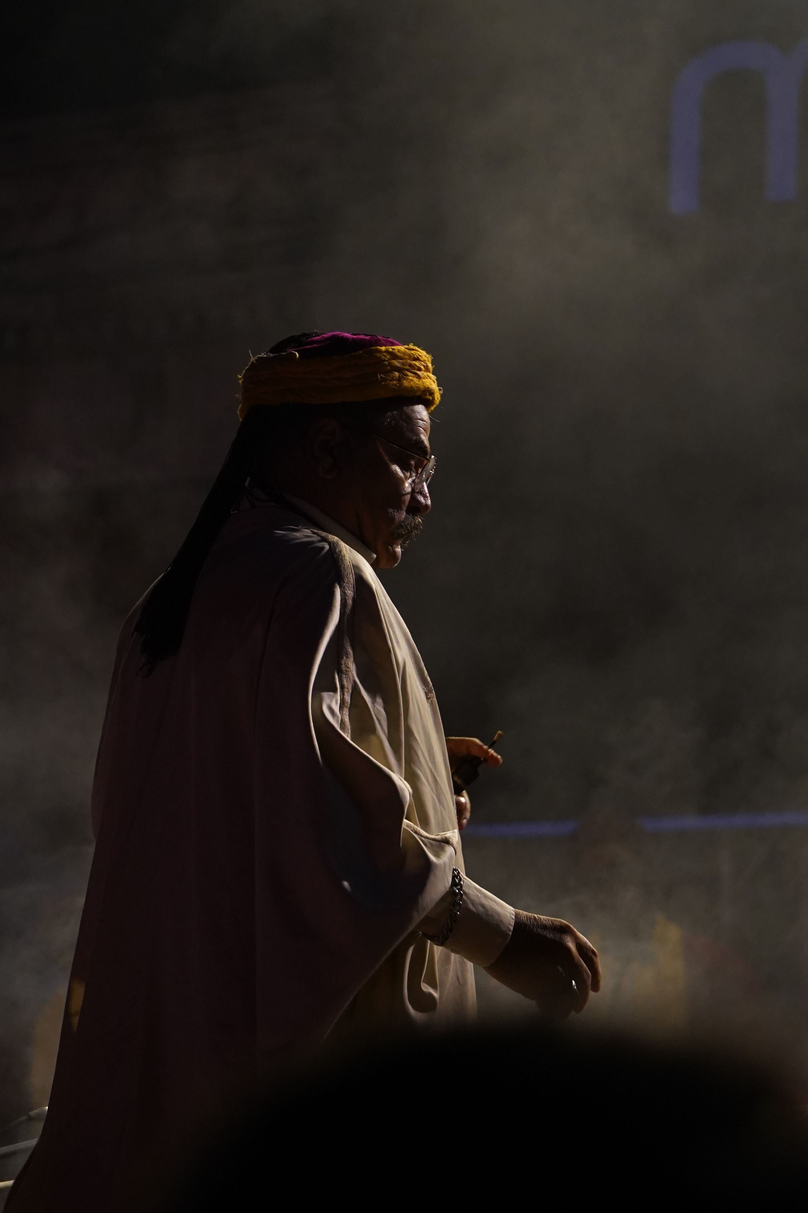 Traditional Tunisian Performer in Dramatic Lighting · Free Stock Photo