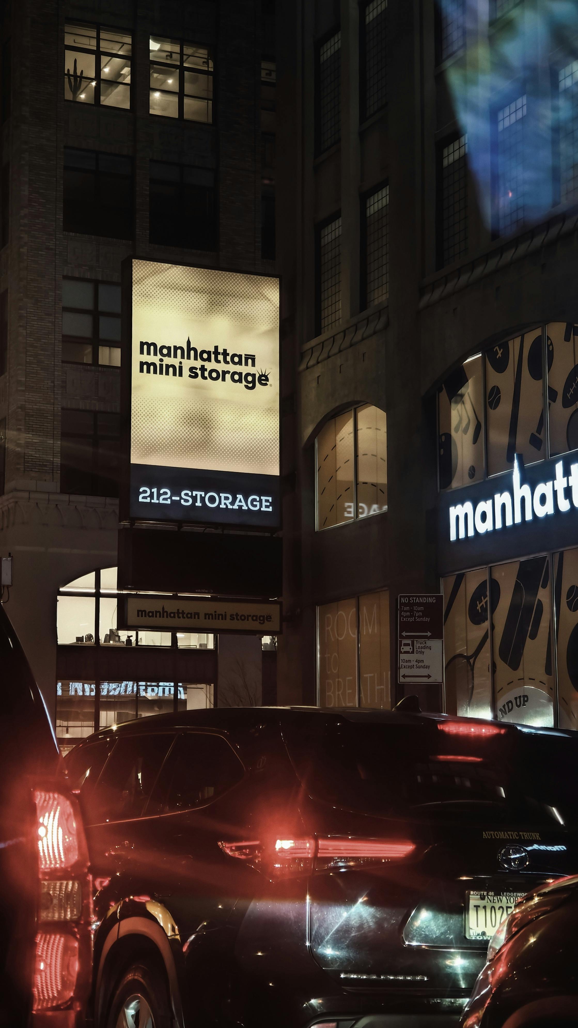 Nighttime View of Manhattan Mini Storage Sign · Free Stock Photo