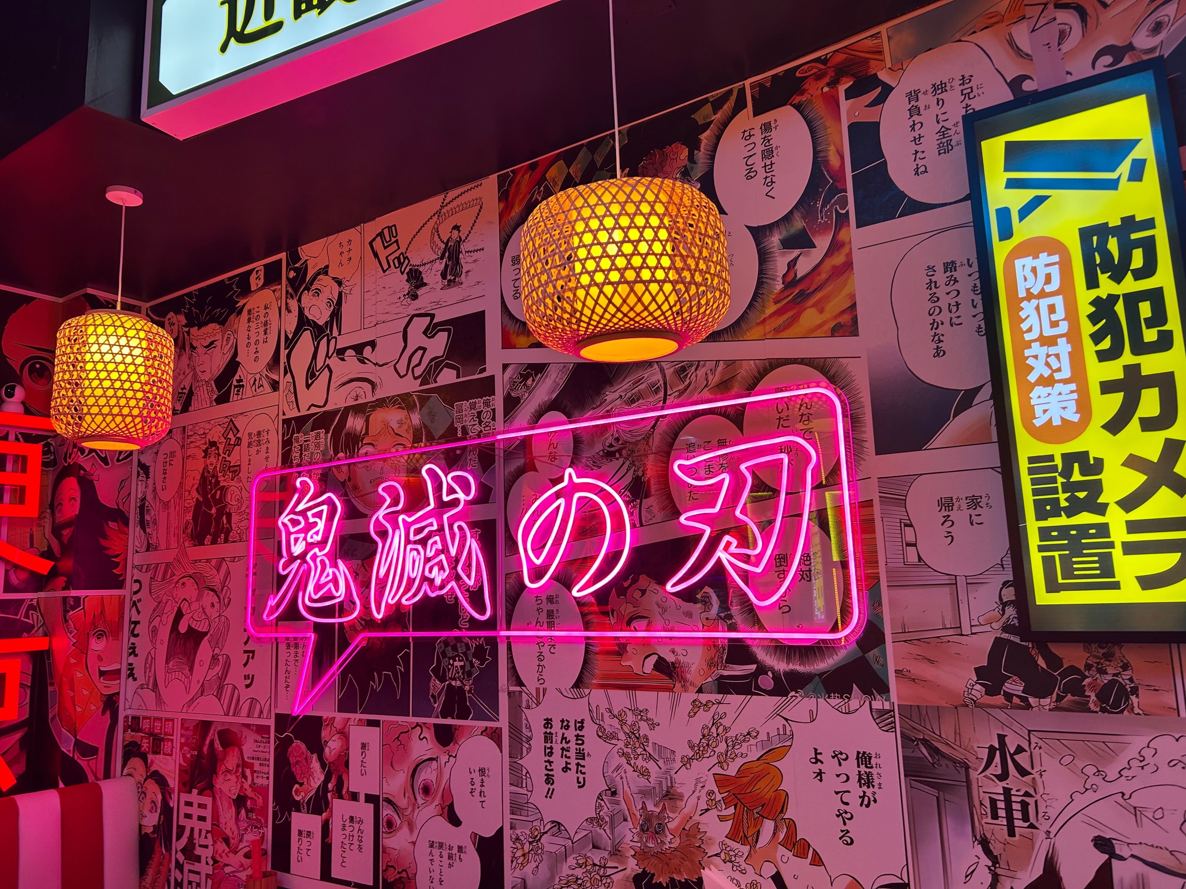Vibrant Neon Sign in Manga-Themed Cafe Interior · Free Stock Photo