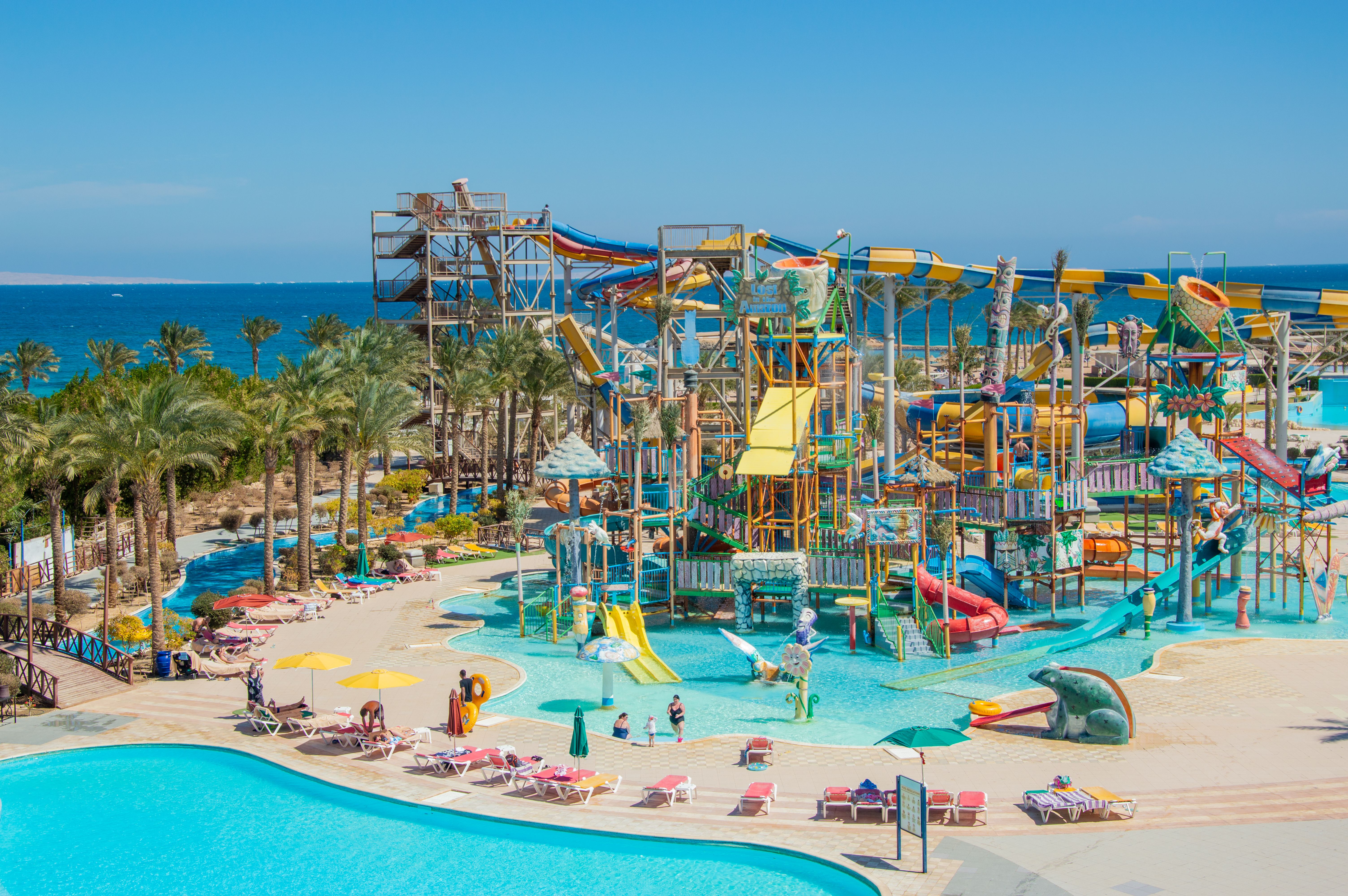 Vibrant Water Park by the Sea with Colorful Slides · Free Stock Photo