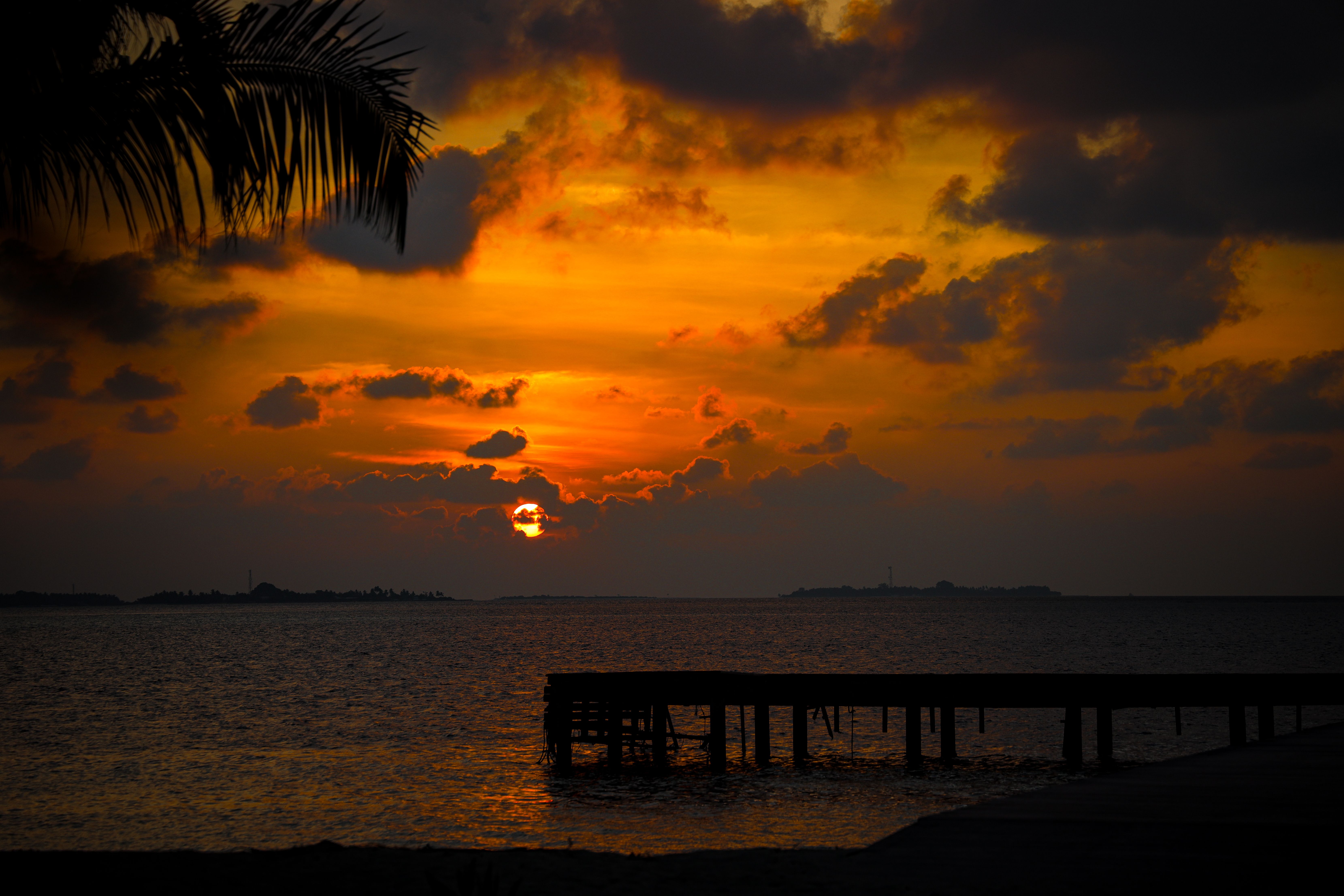 Stunning Beach Sunset Over Calm Waters · Free Stock Photo