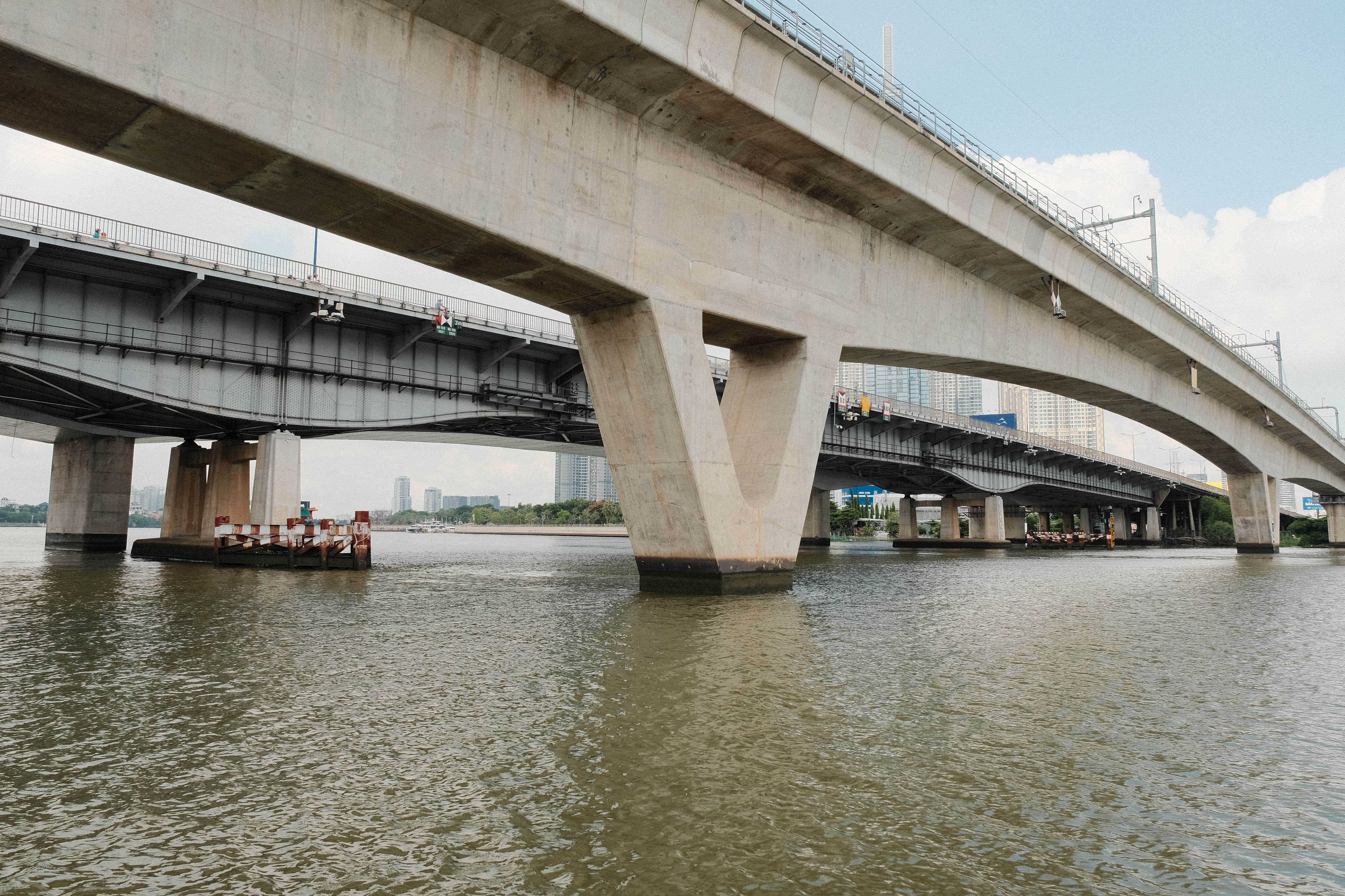 Concrete Bridge Over River with City View · Free Stock Photo