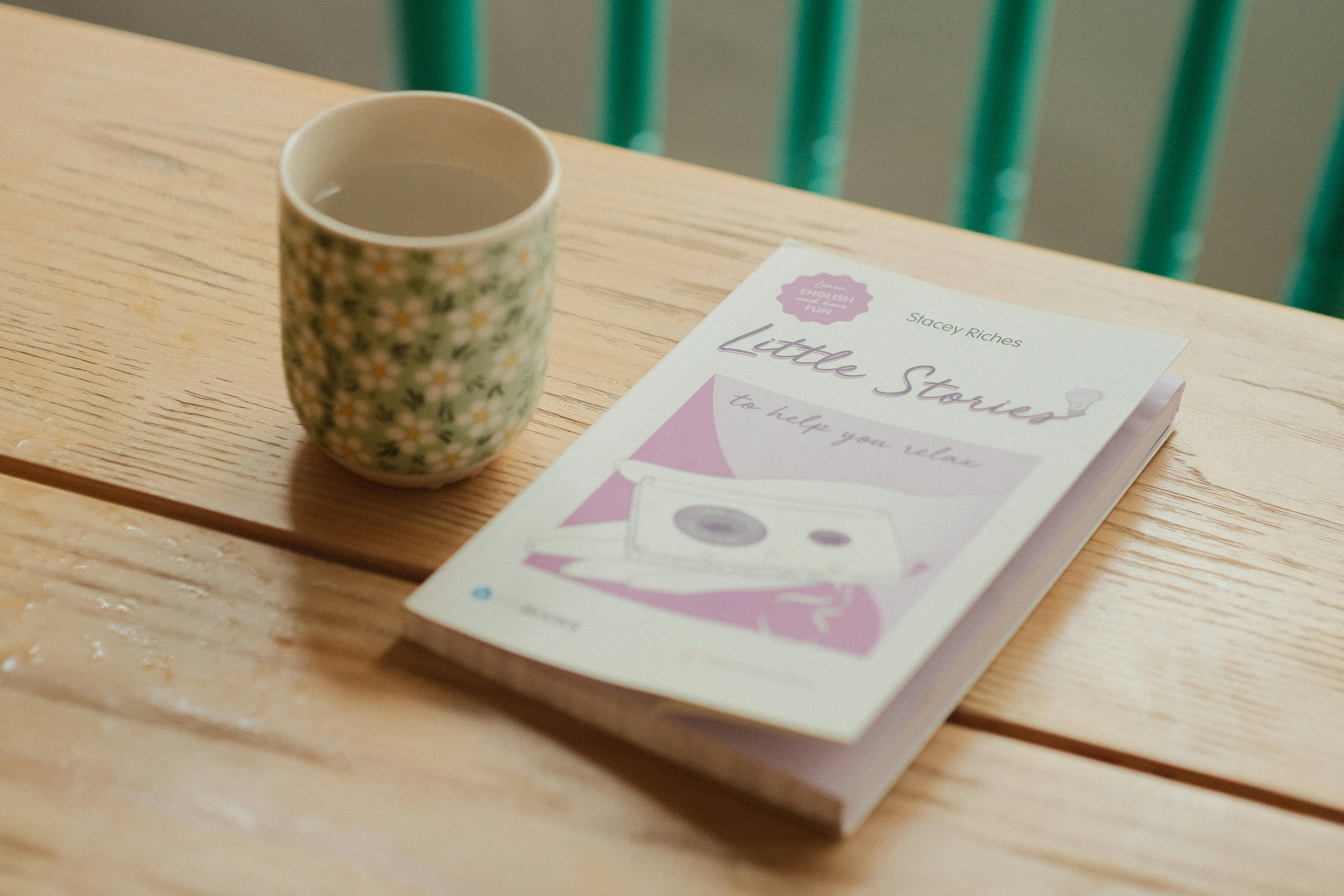 Cozy Reading Setup with a Book and Cup · Free Stock Photo