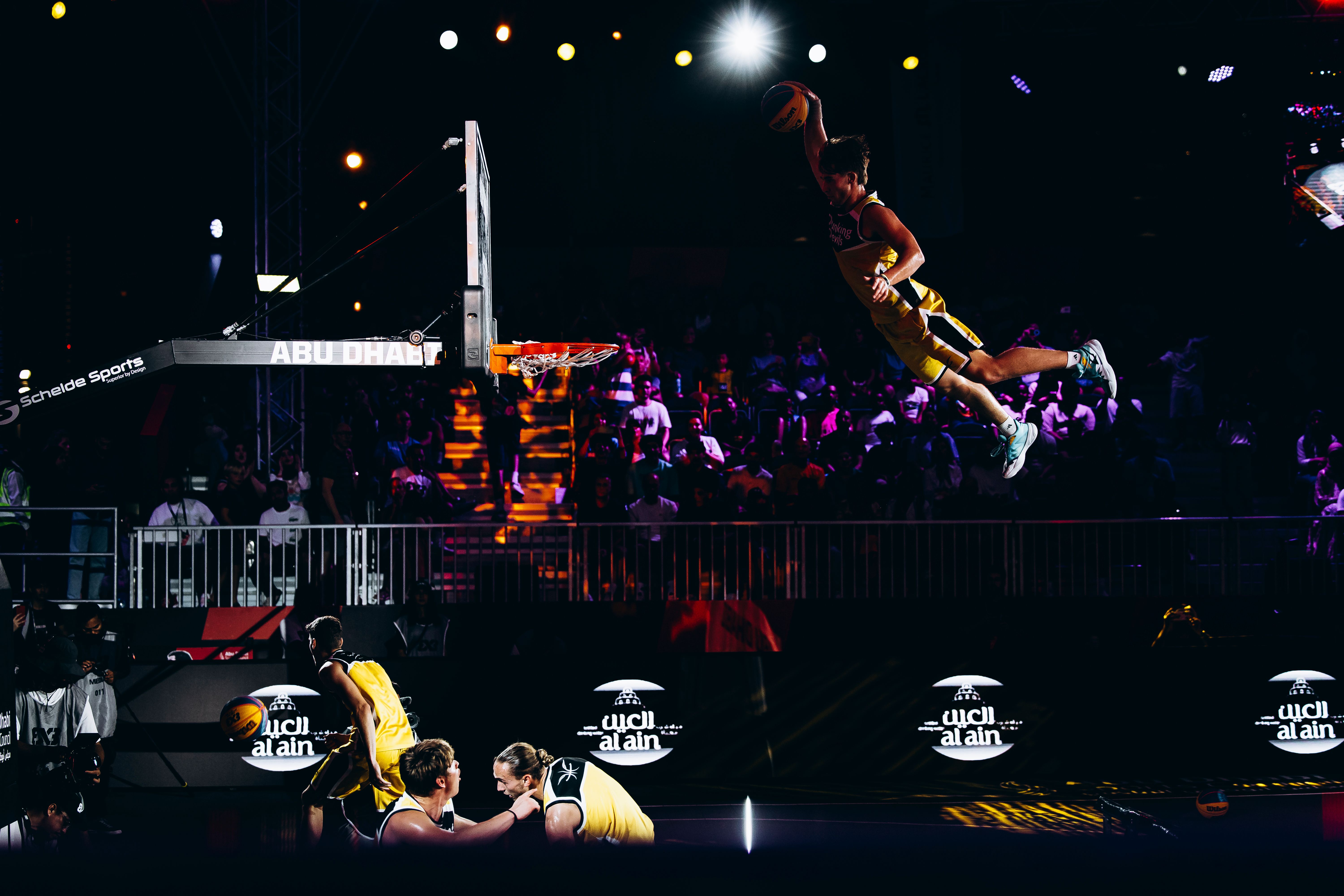 Dynamic Slam Dunk Under Bright Arena Lights · Free Stock Photo