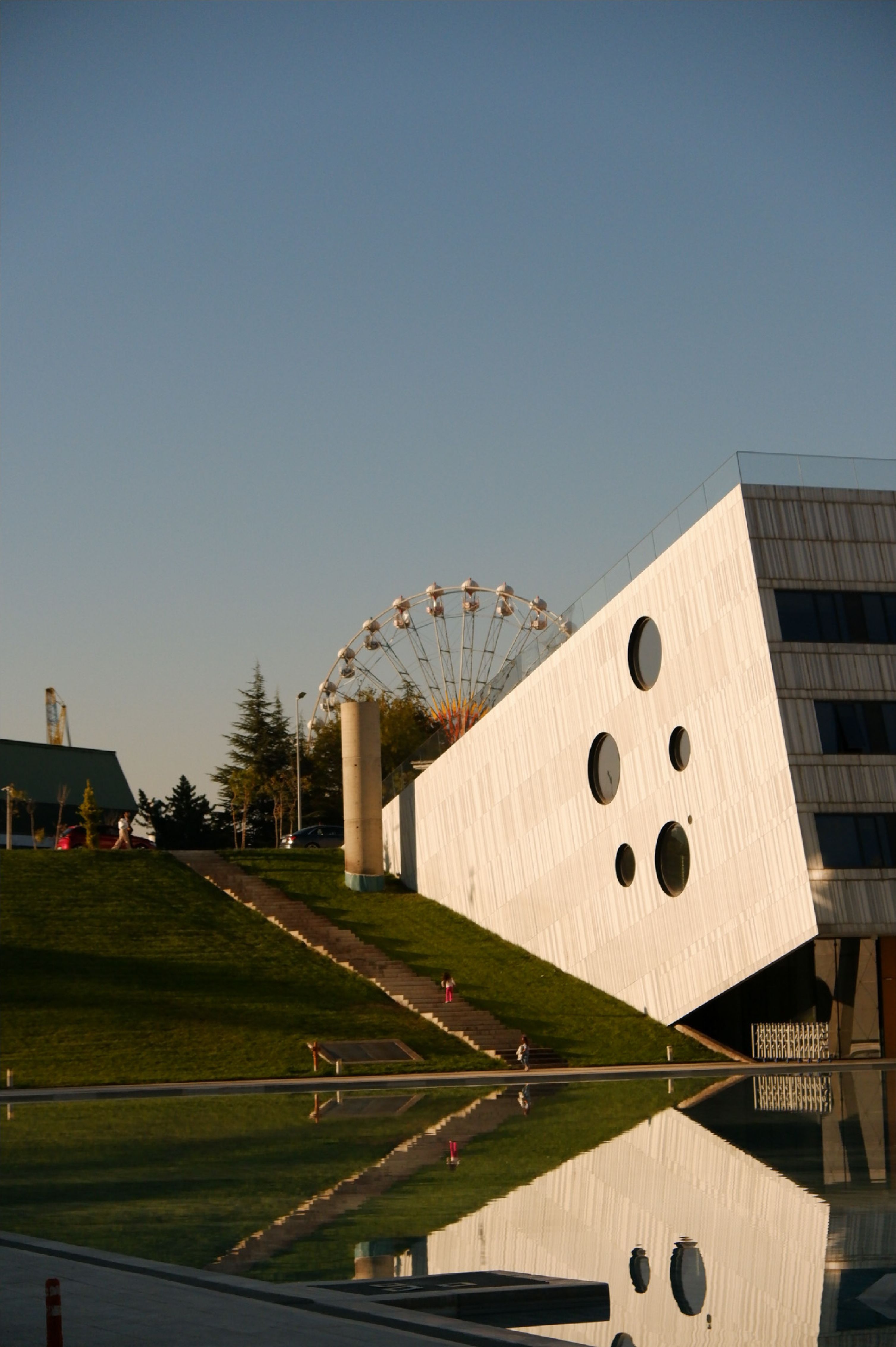 Modern architecture with Ferris wheel in background · Free Stock Photo