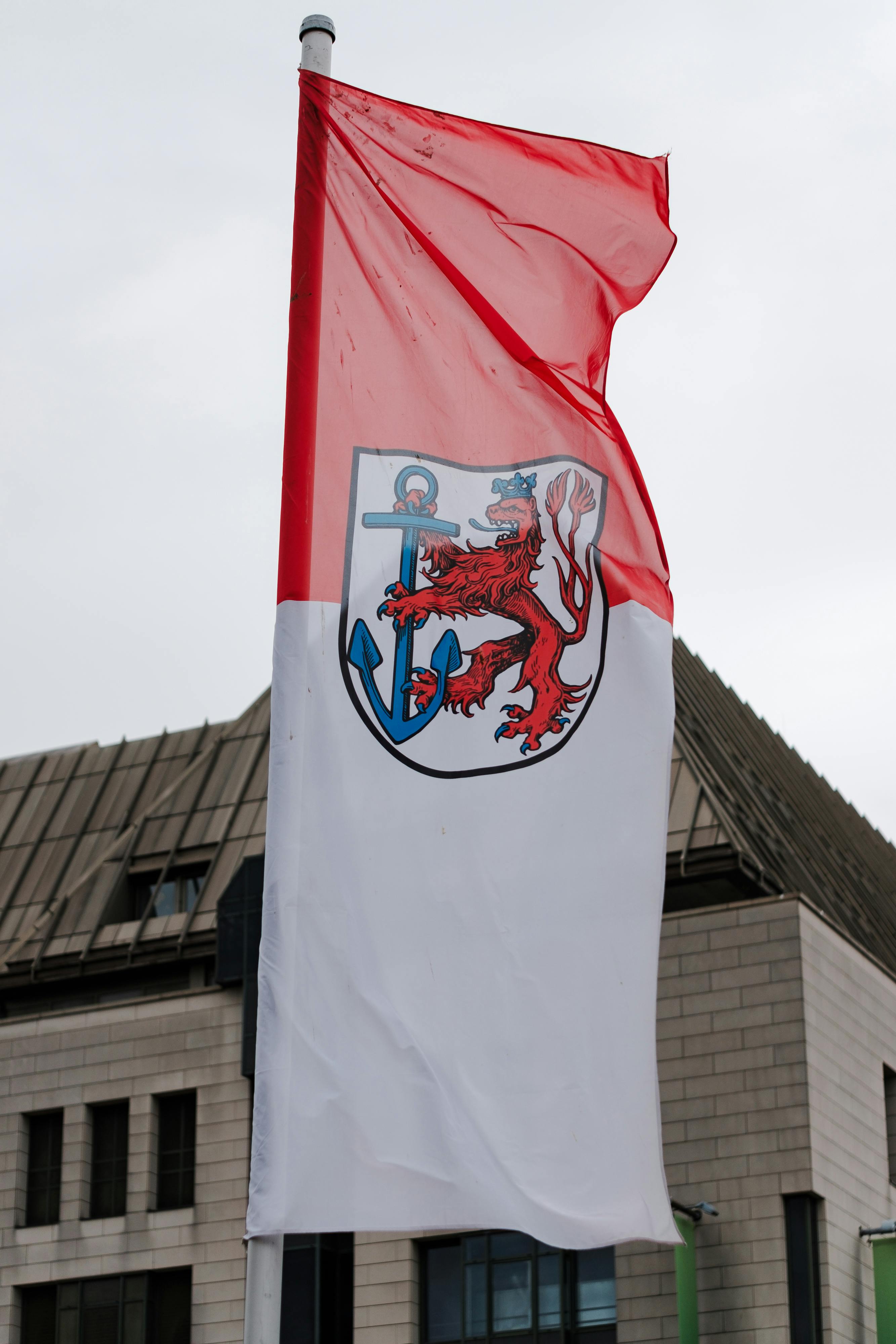 Düsseldorf City Flag with Coat of Arms Waving Outdoors · Free Stock Photo