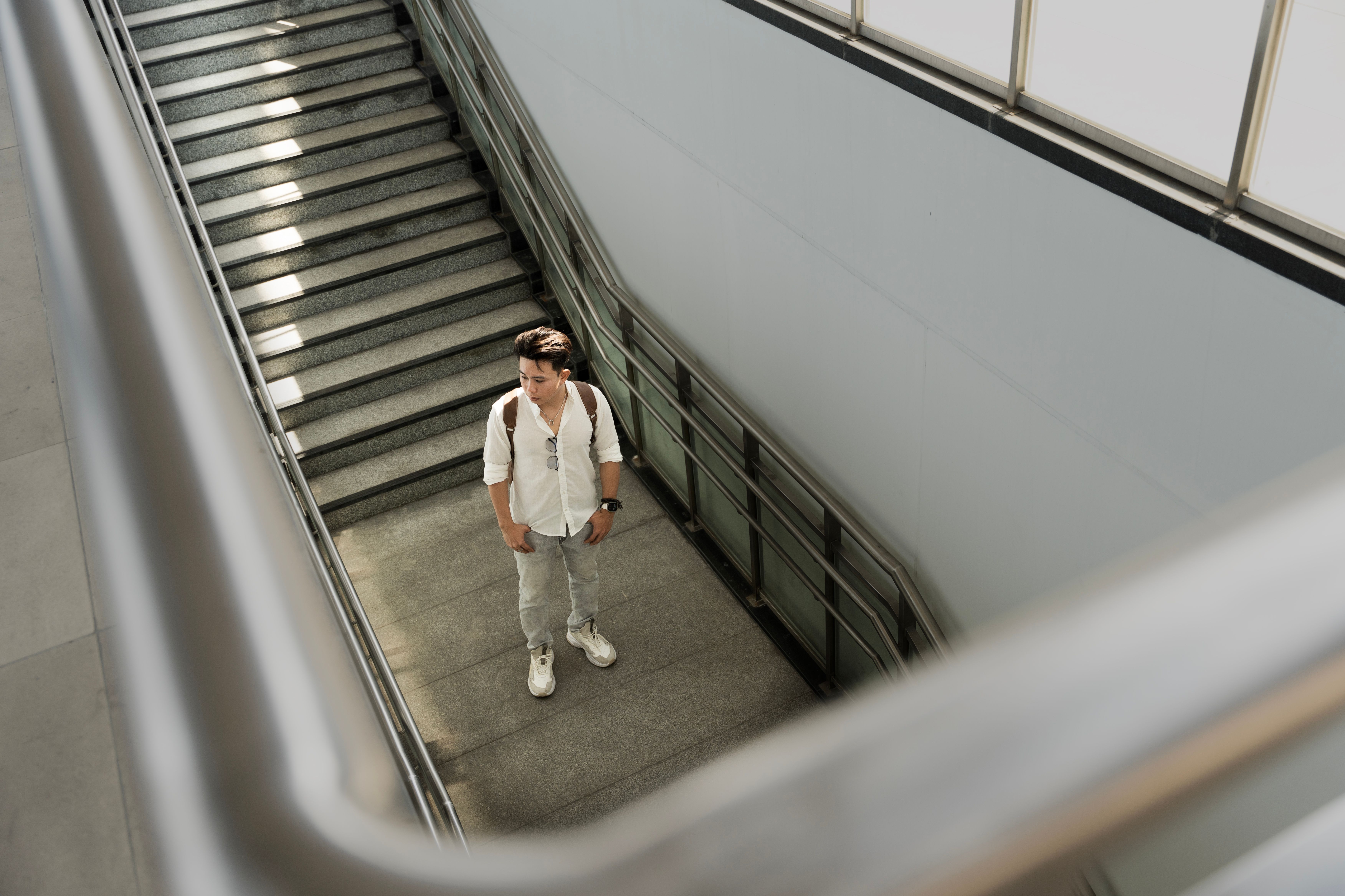Young Man Standing on Staircase from Above View · Free Stock Photo