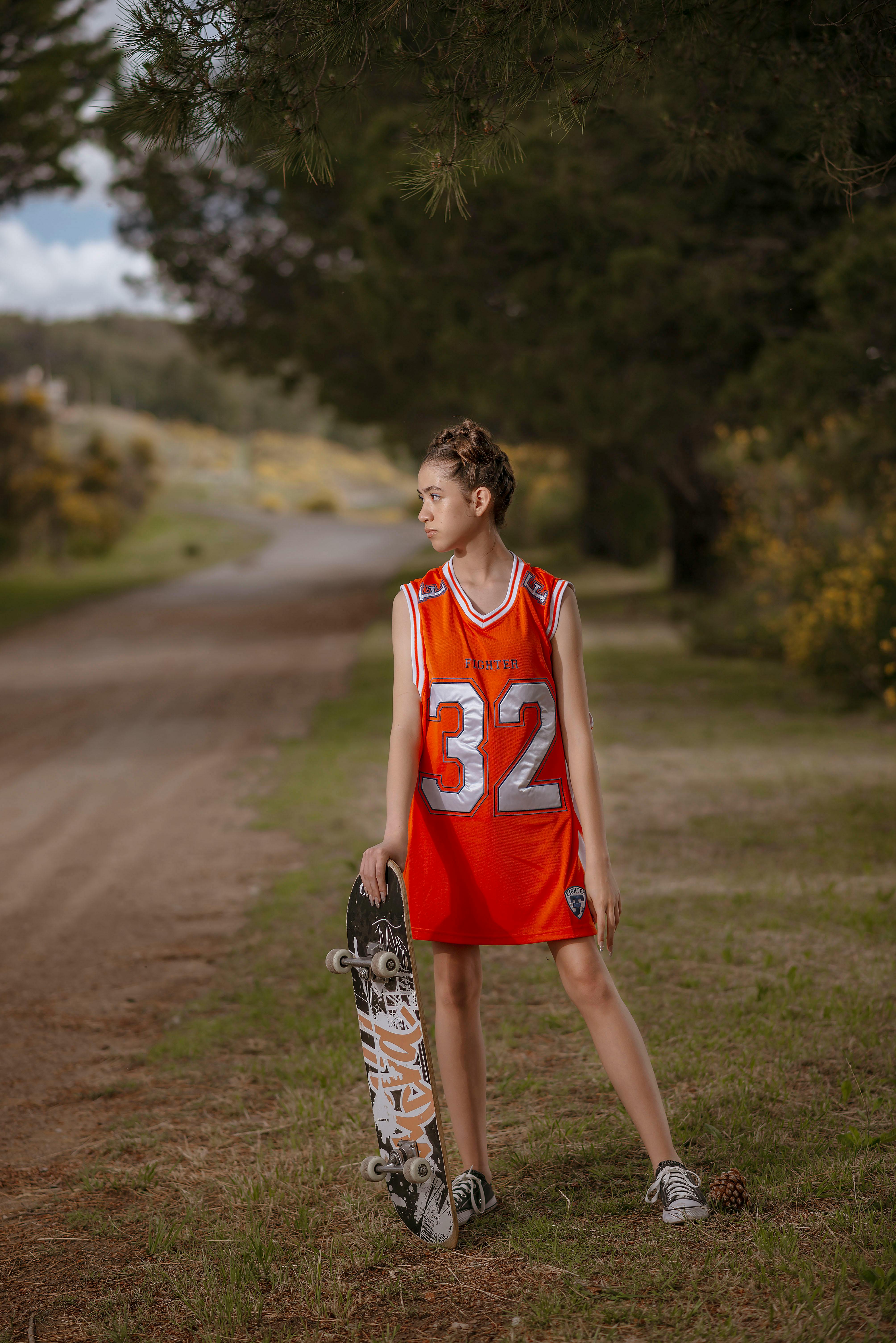 Young Woman Skateboarding in a Forested Pathway · Free Stock Photo