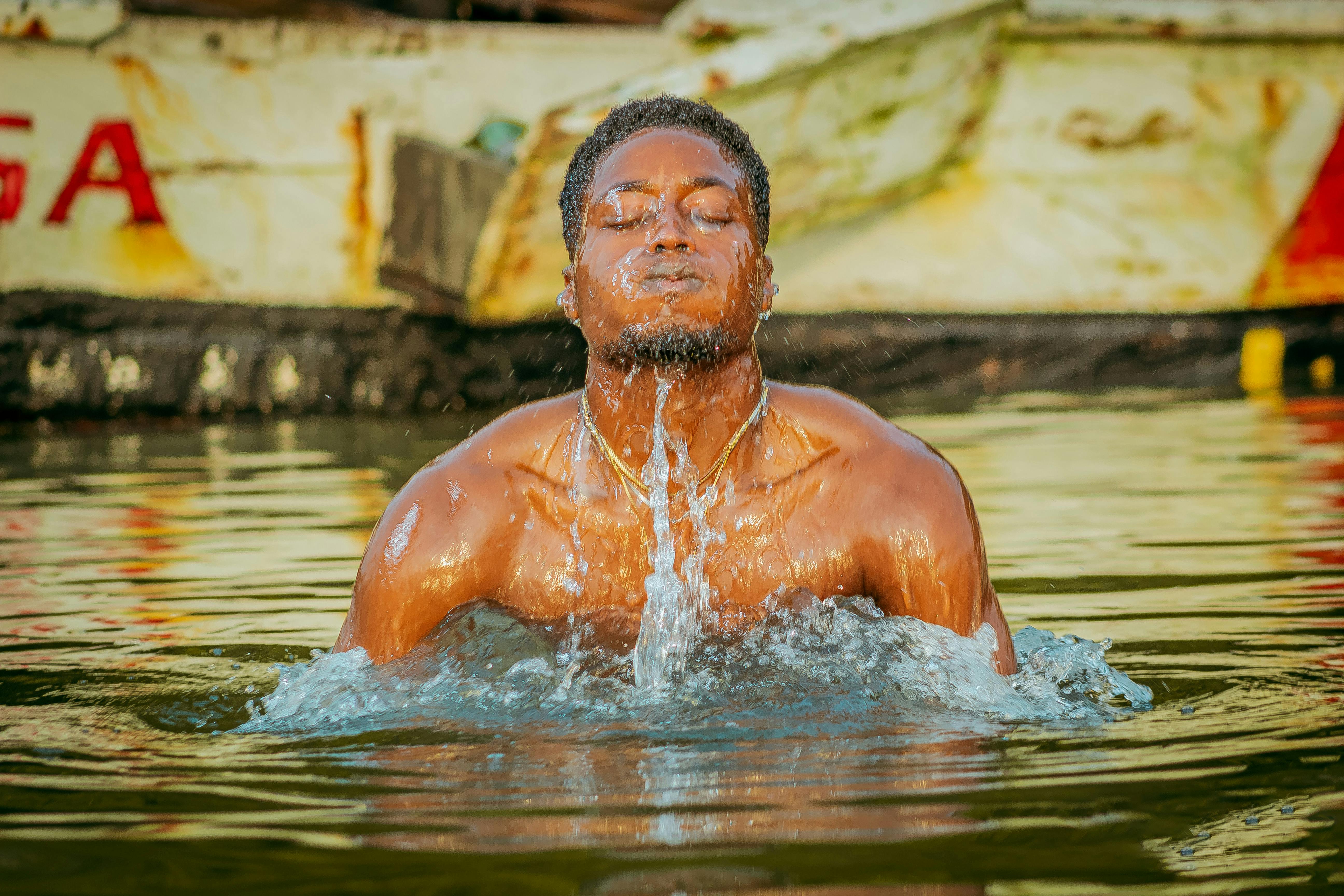 Man Emerging from Water in Tema, Ghana · Free Stock Photo