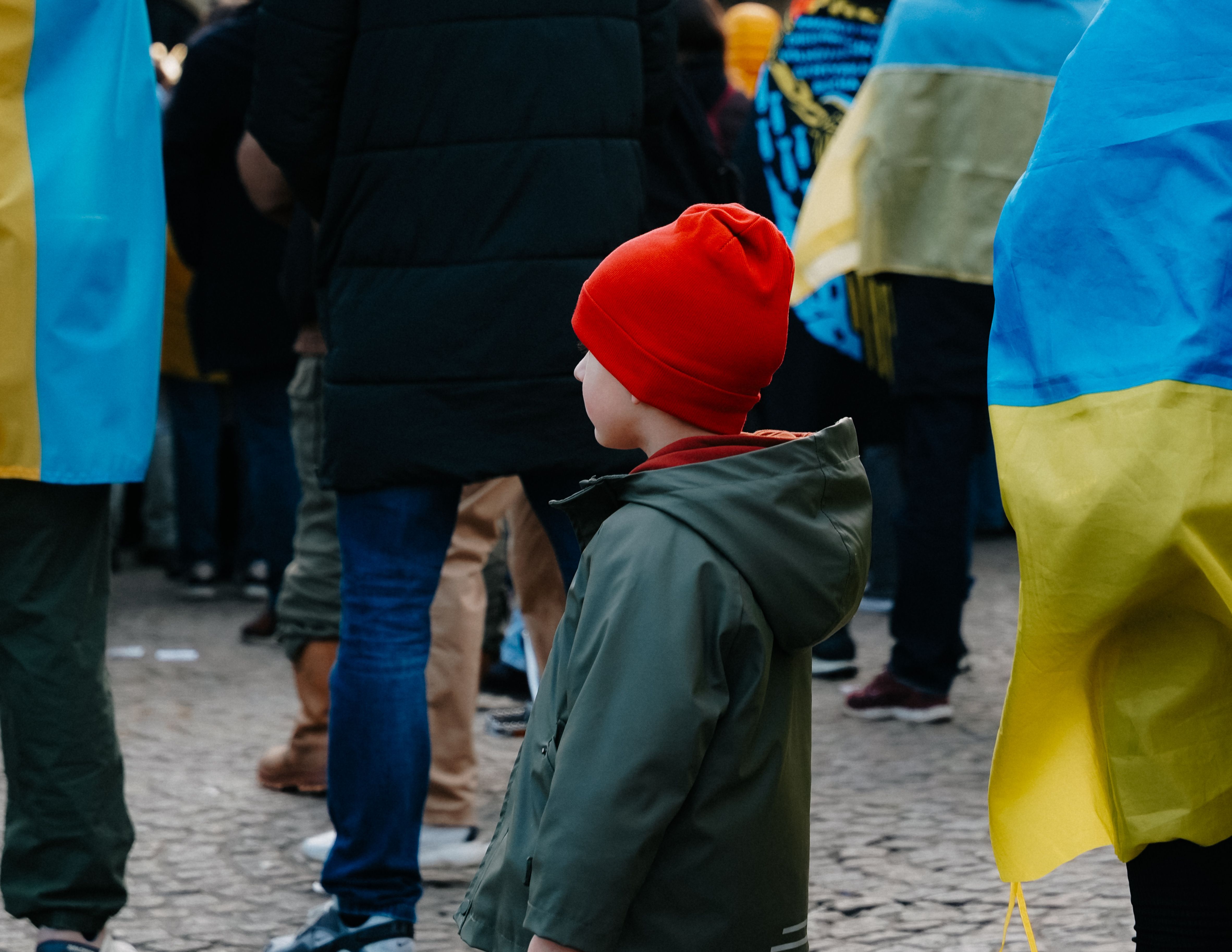 Child in Red Beanie at Amsterdam Protest · Free Stock Photo