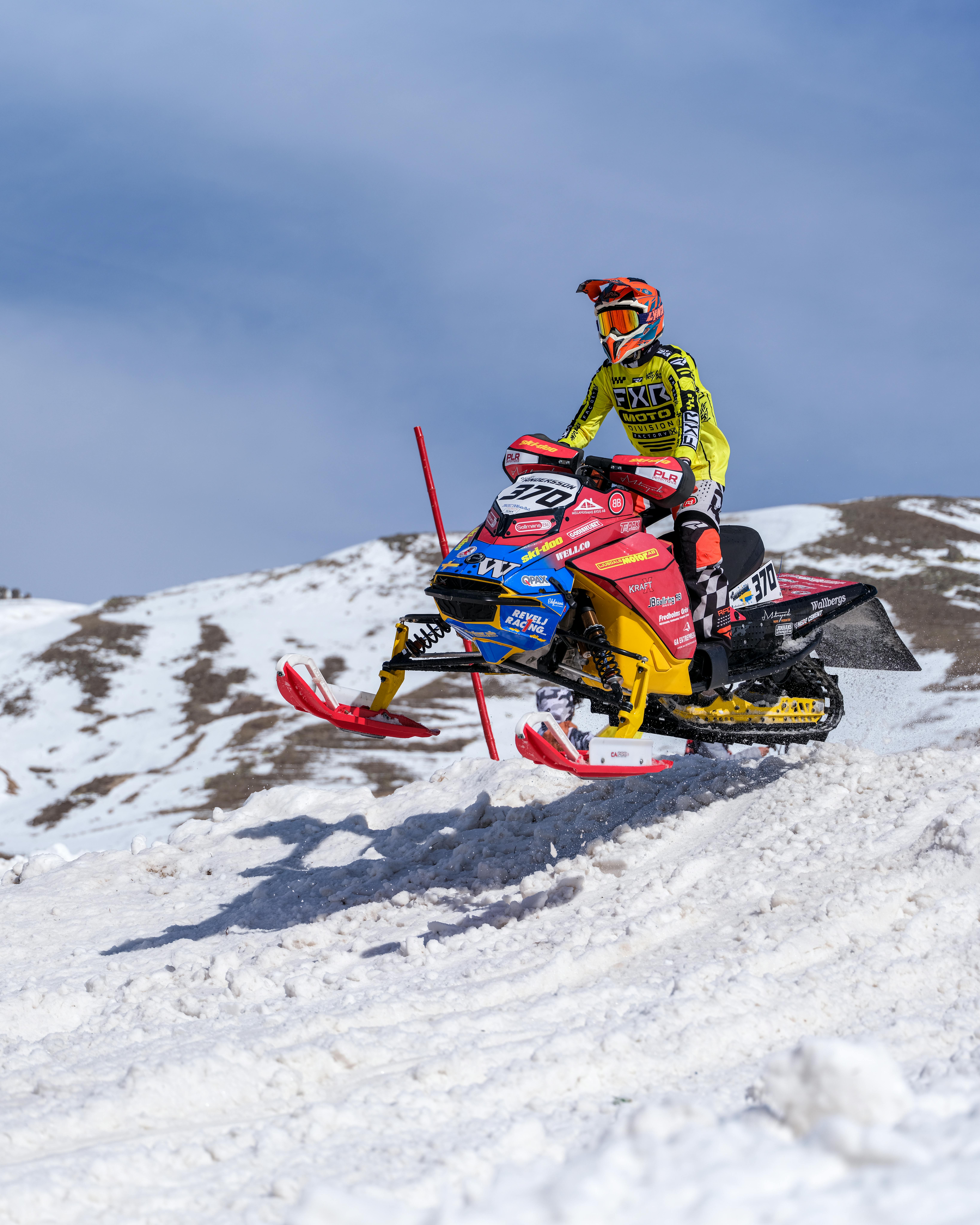 Dynamic Snowmobile Racing in Winter Landscape · Free Stock Photo
