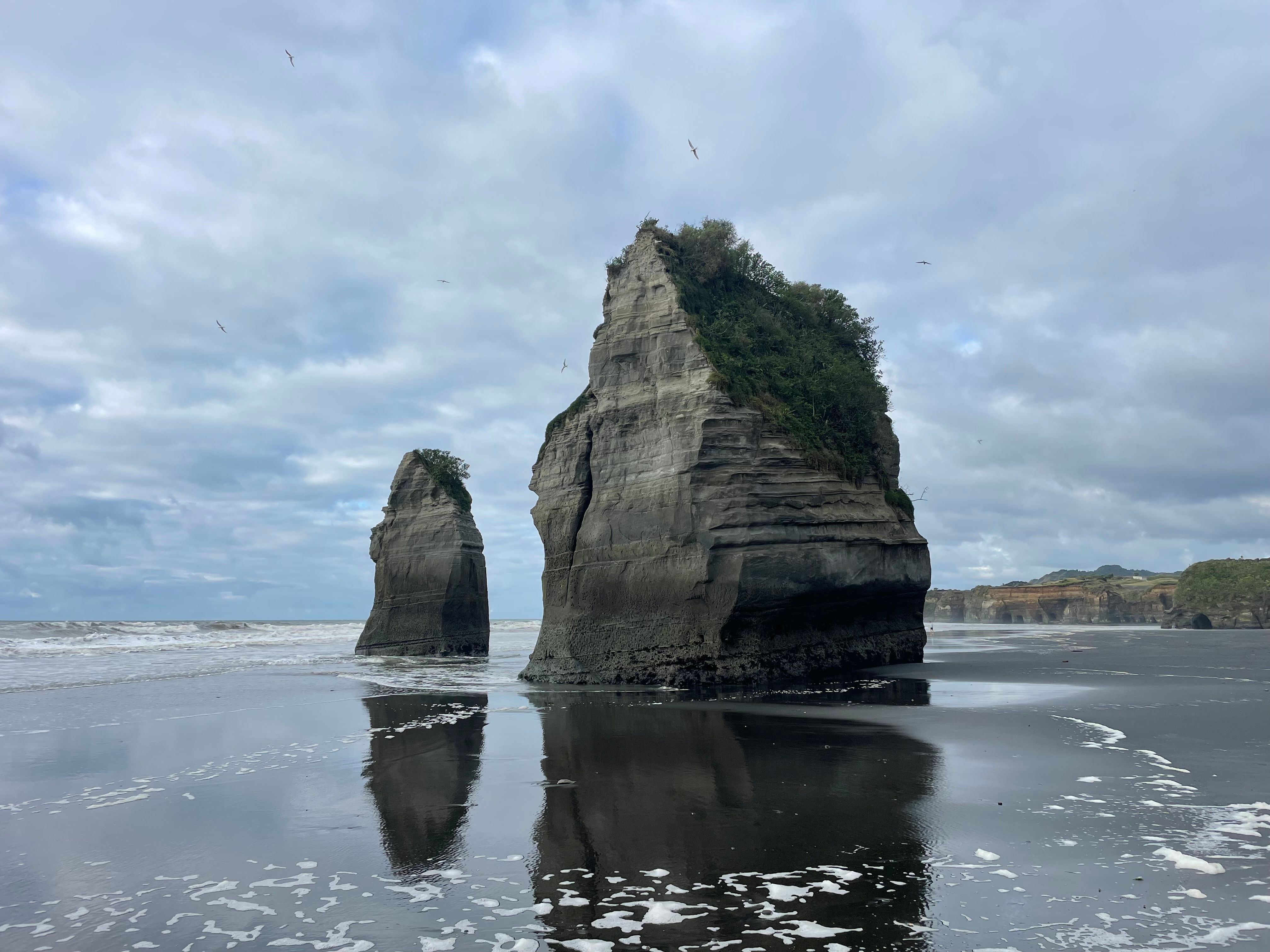 Majestic Sea Stacks on a Cloudy Coastline · Free Stock Photo