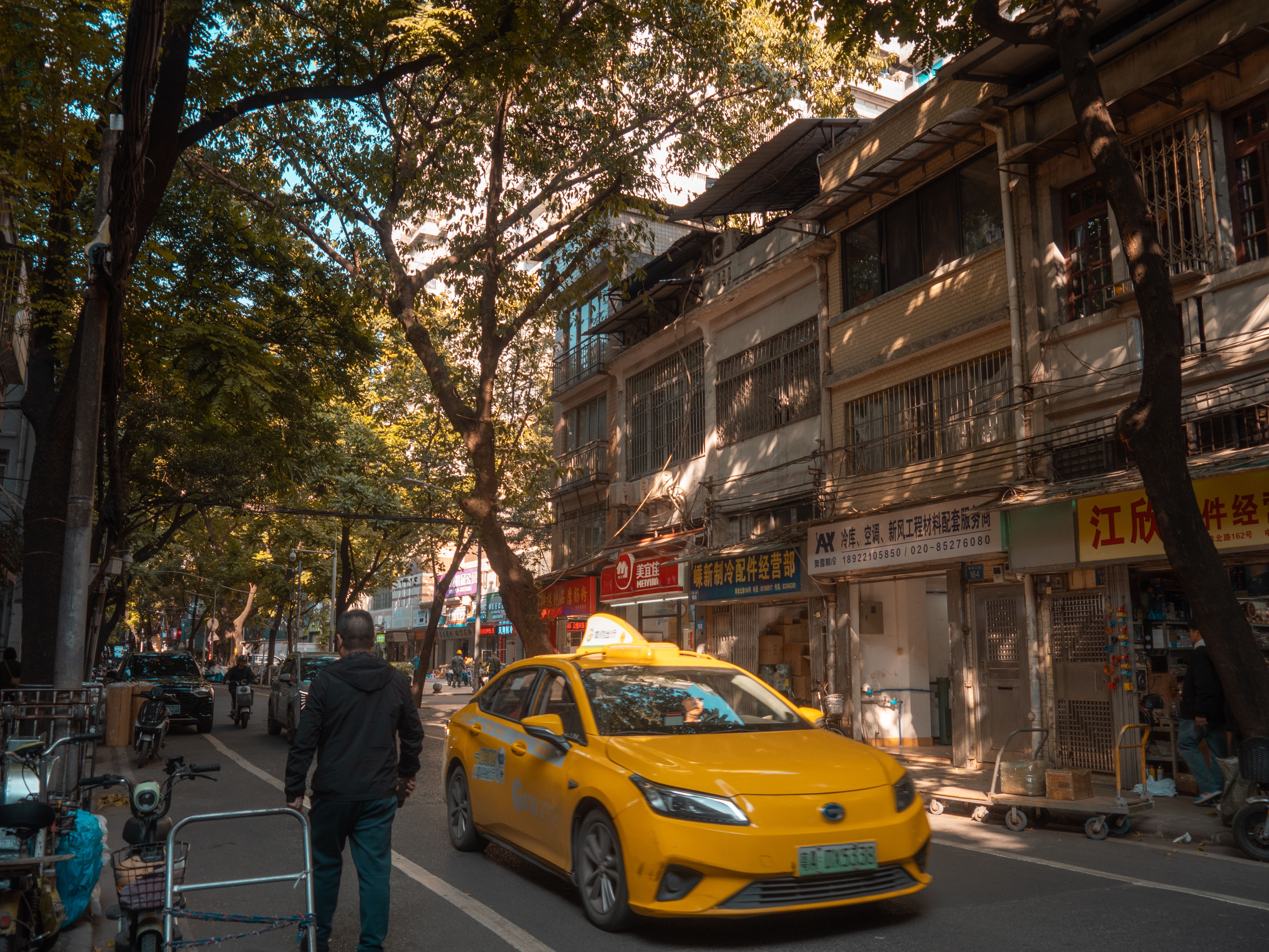 Busy Street Scene with Yellow Taxi in Urban Setting · Free Stock Photo