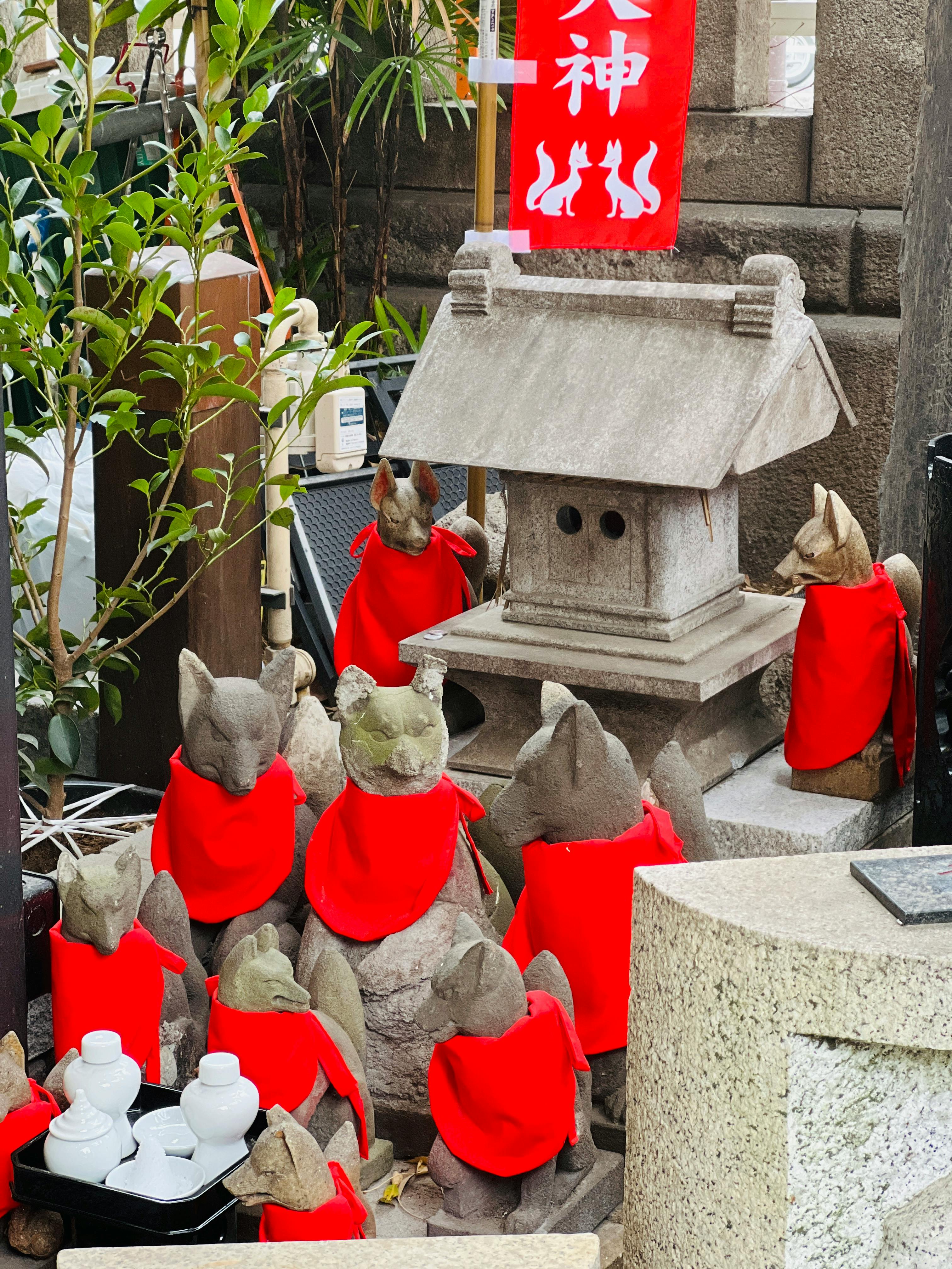 Japanese Inari Shrine with Fox Statues and Red Bibs · Free Stock Photo