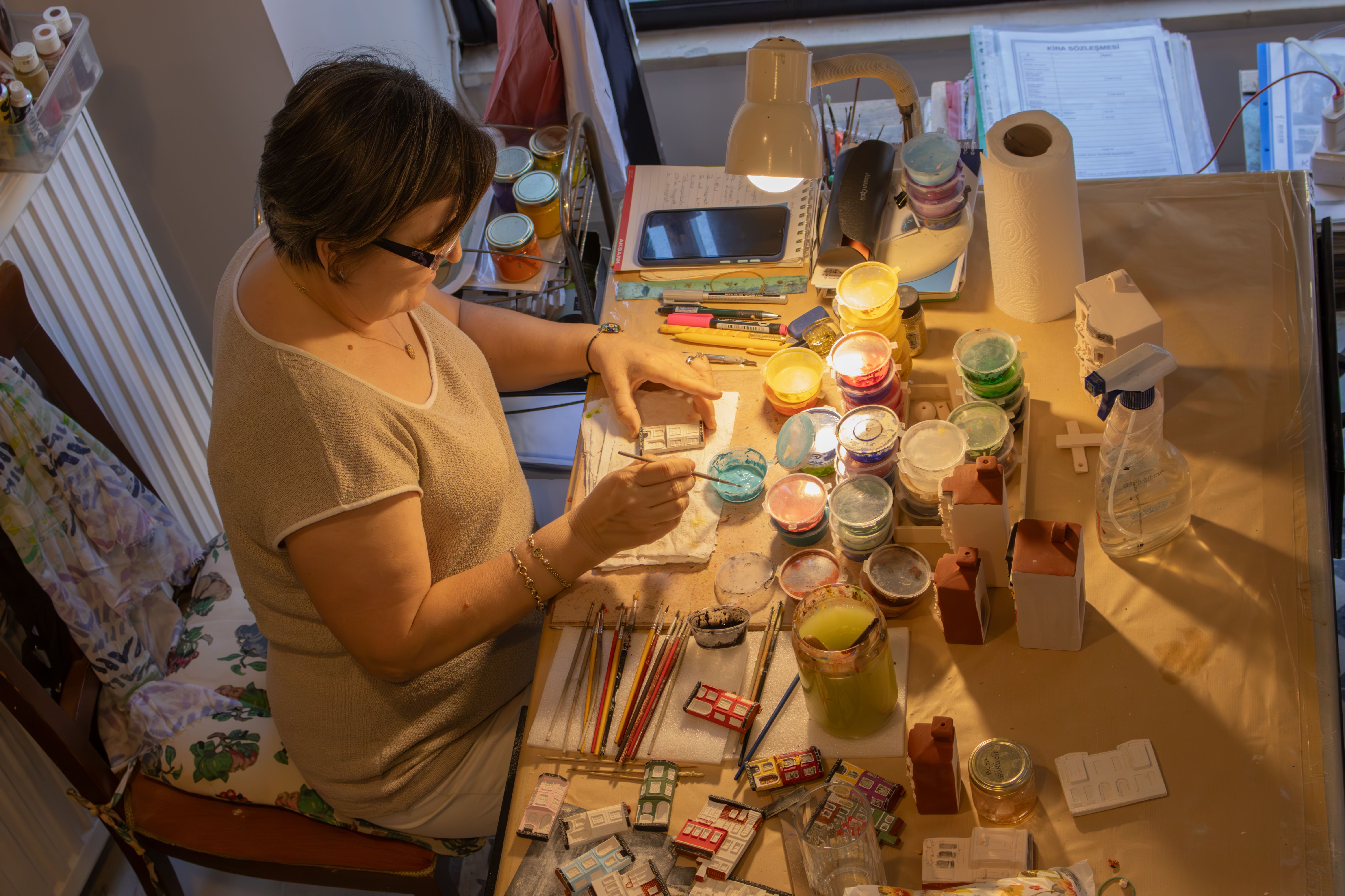 Artisan Painting Small Models in a Cozy Studio · Free Stock Photo