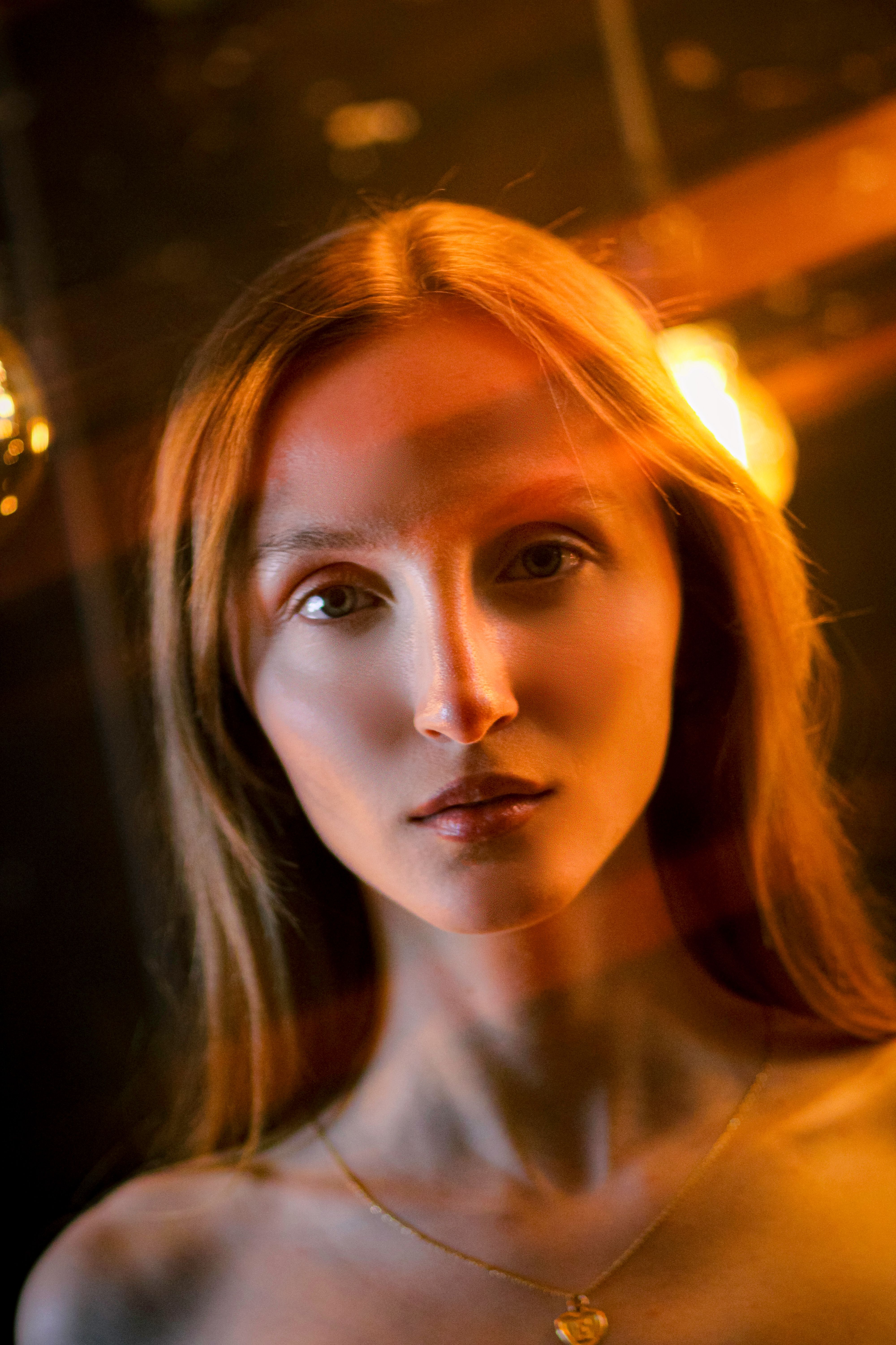 Moody Portrait of a Young Woman with Warm Lighting · Free Stock Photo