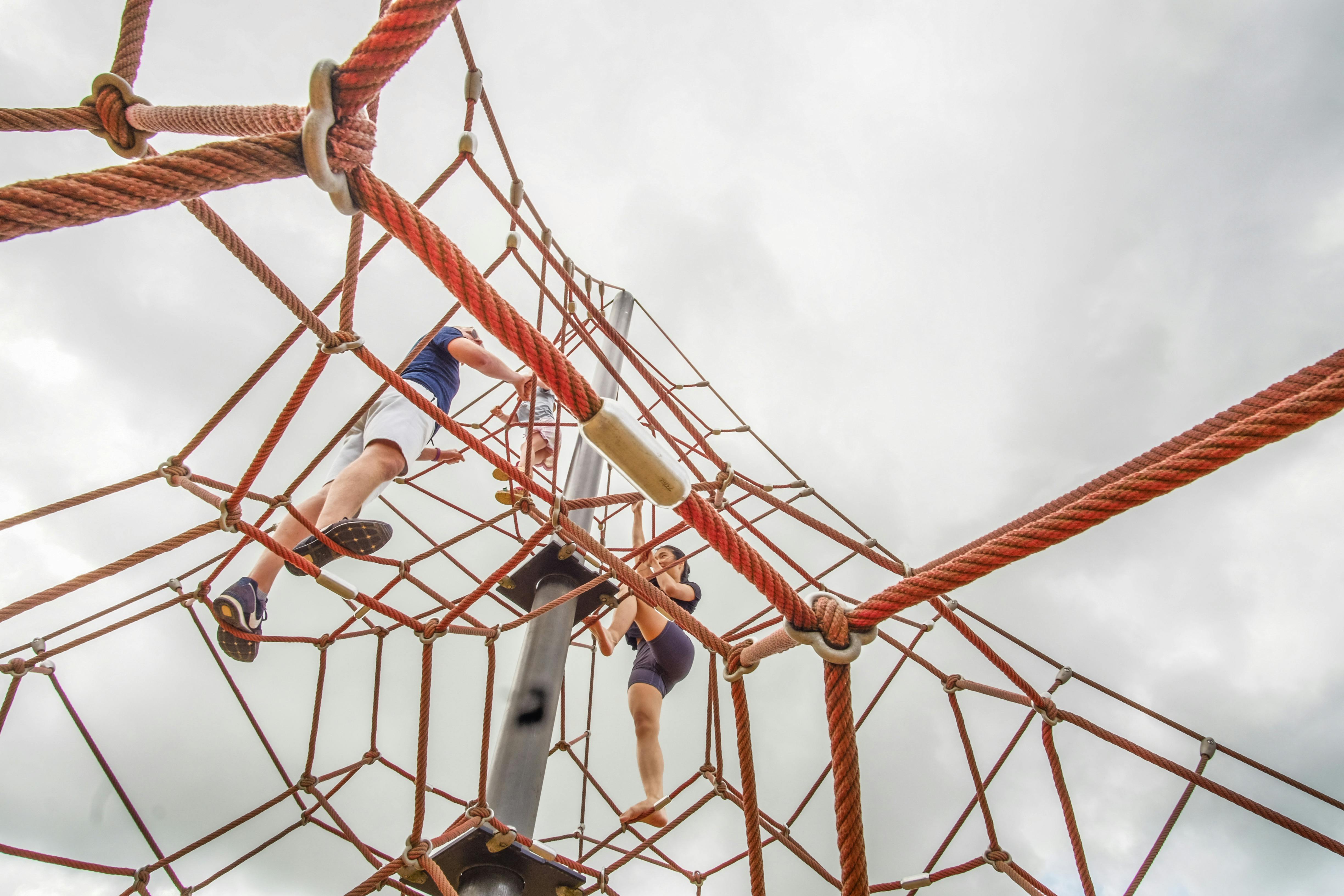 Children climbing rope playground structure outdoors · Free Stock Photo