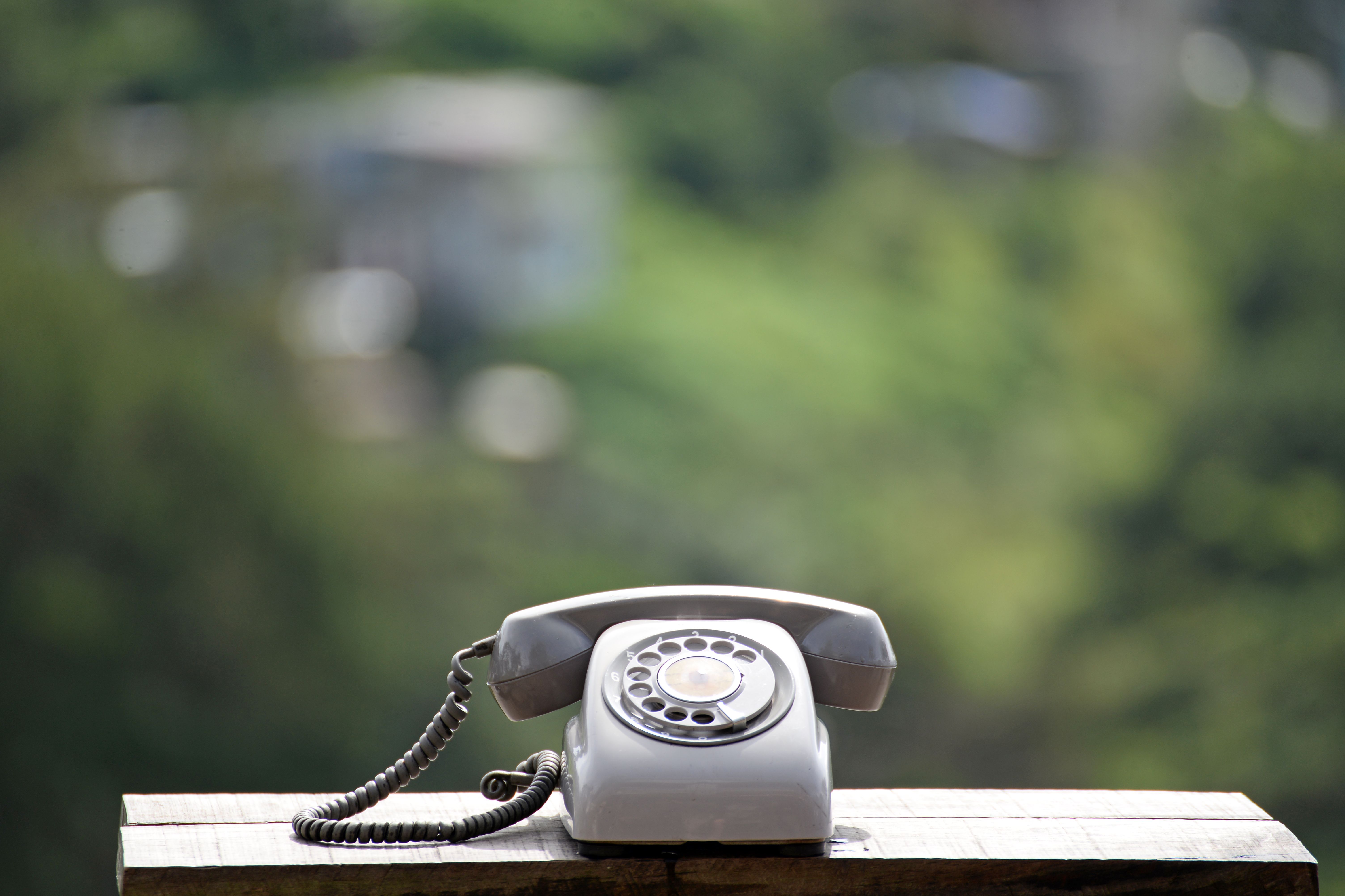 Red Rotary Phone With Black Wheels Near Brown Grasses during Day Time ...