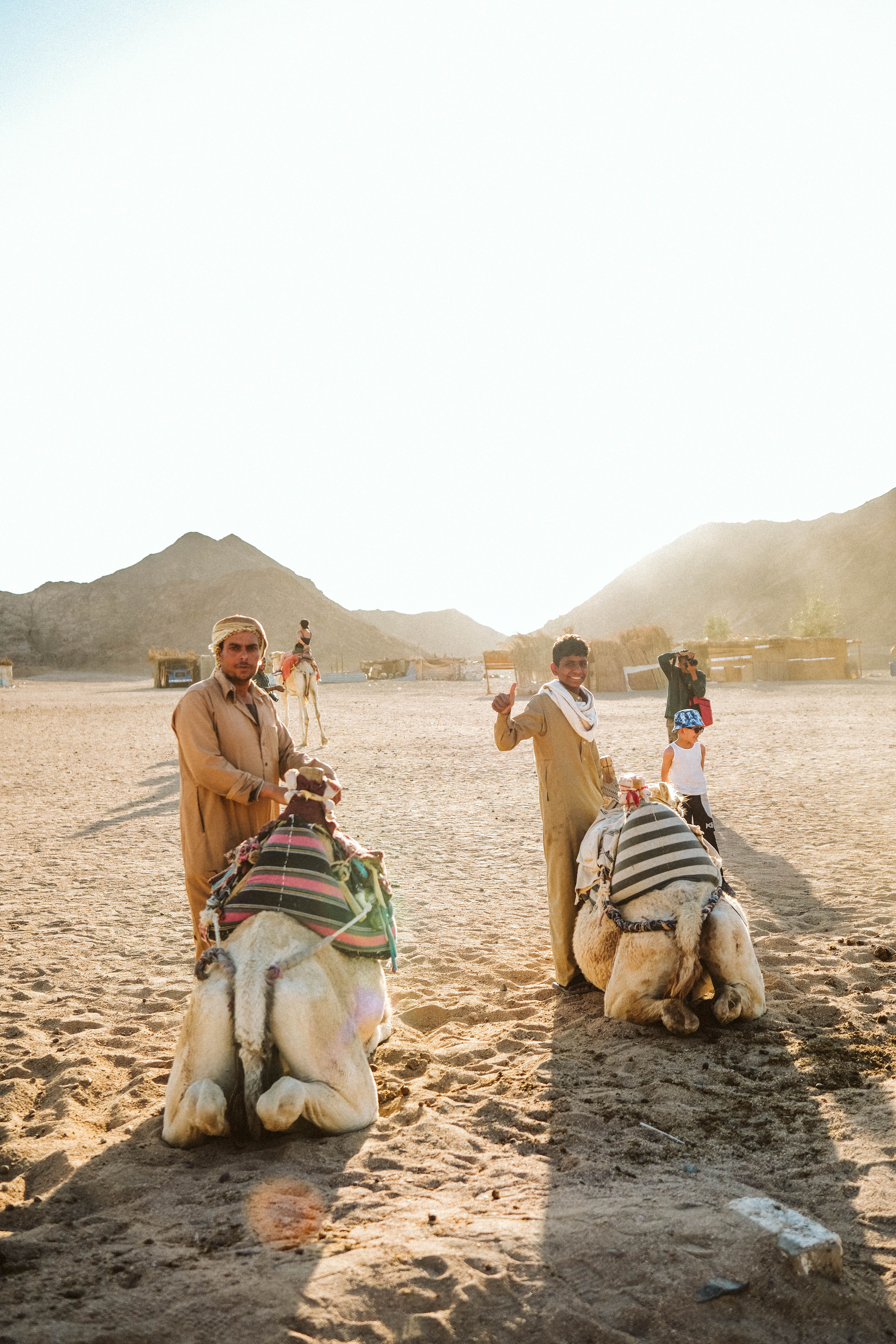 Camel Riders in Desert Landscape at Sunset · Free Stock Photo