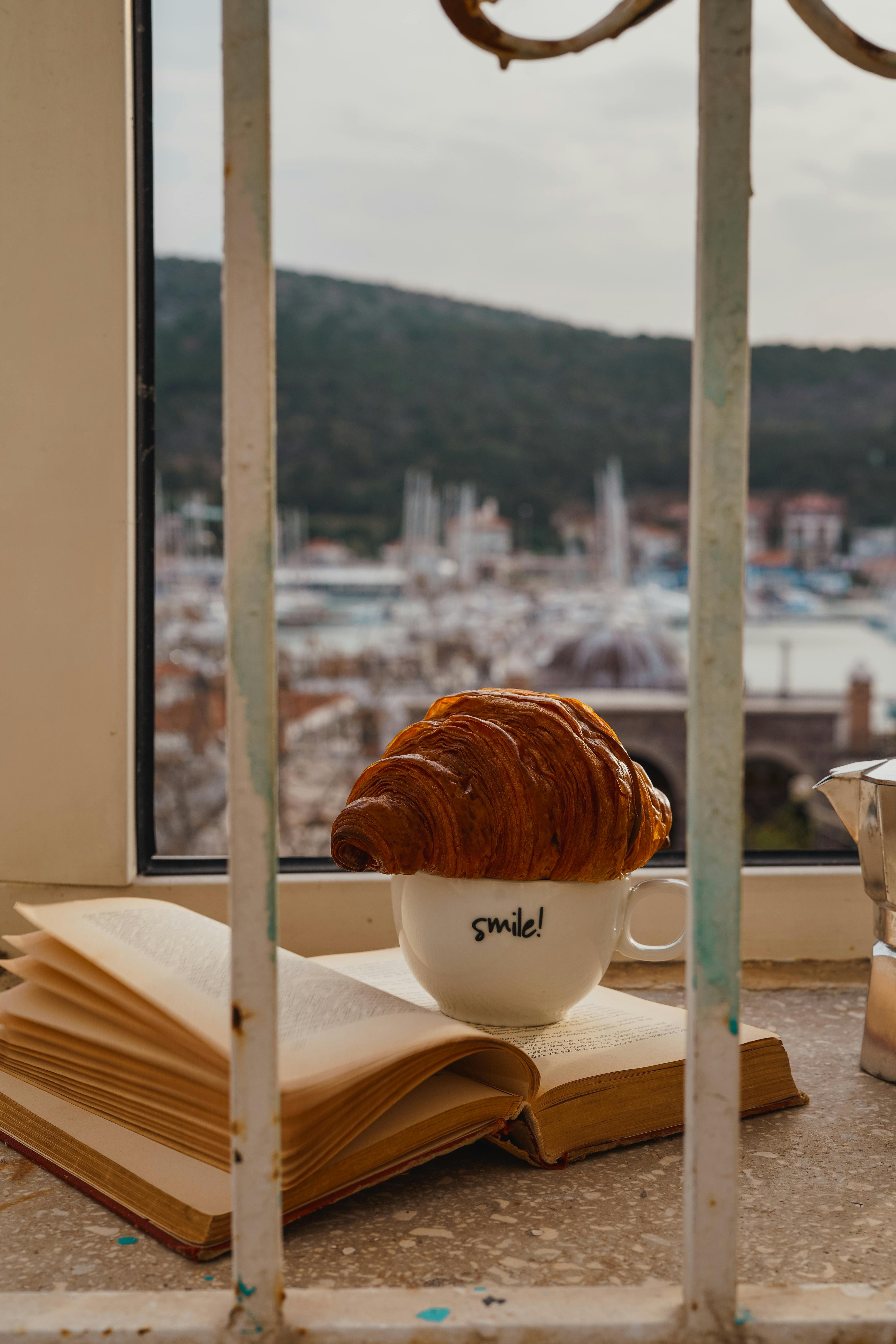 Cozy Window View with Coffee and Croissant · Free Stock Photo