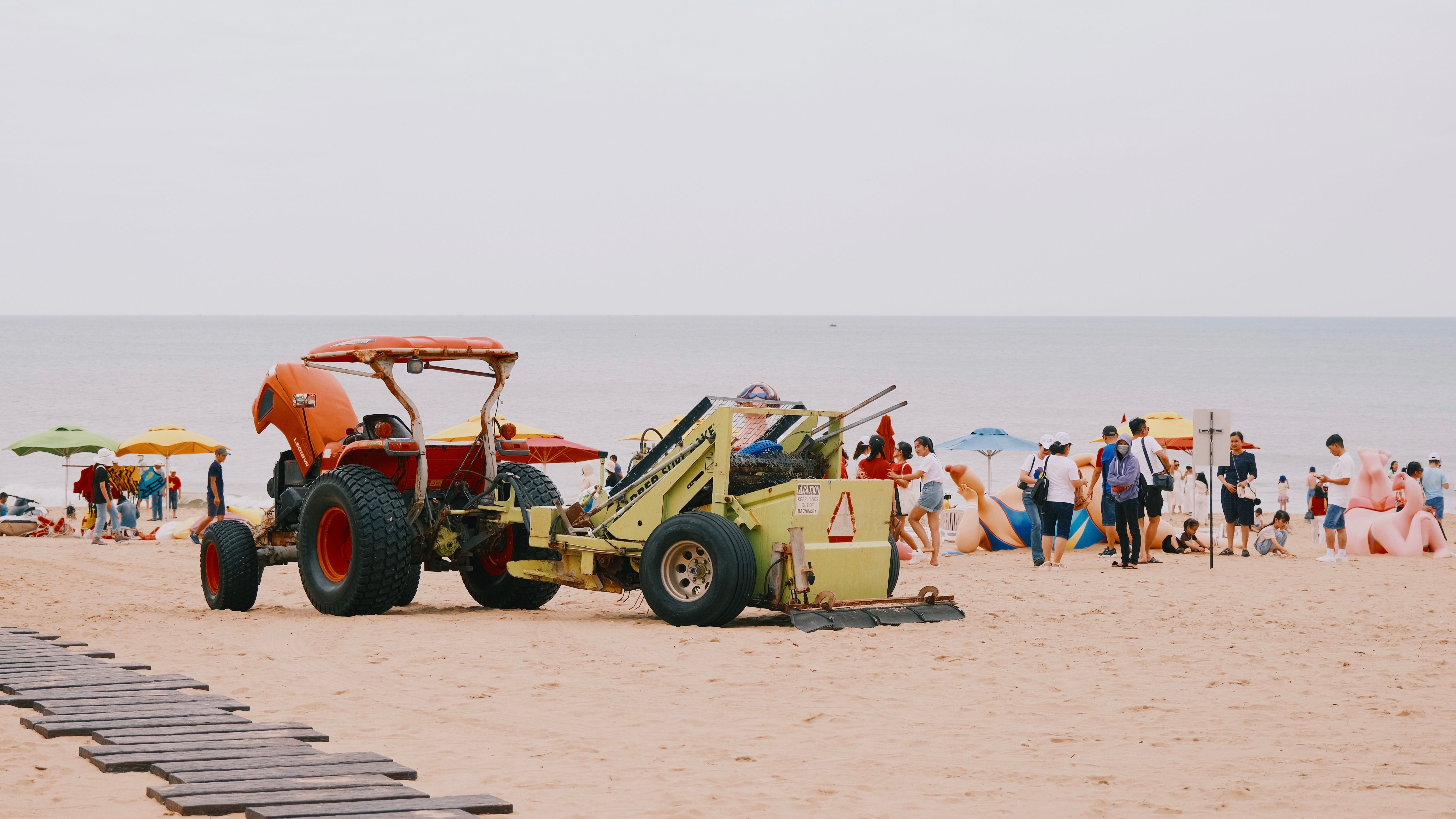 Tractor on Busy Beach with Tourists in Summer · Free Stock Photo