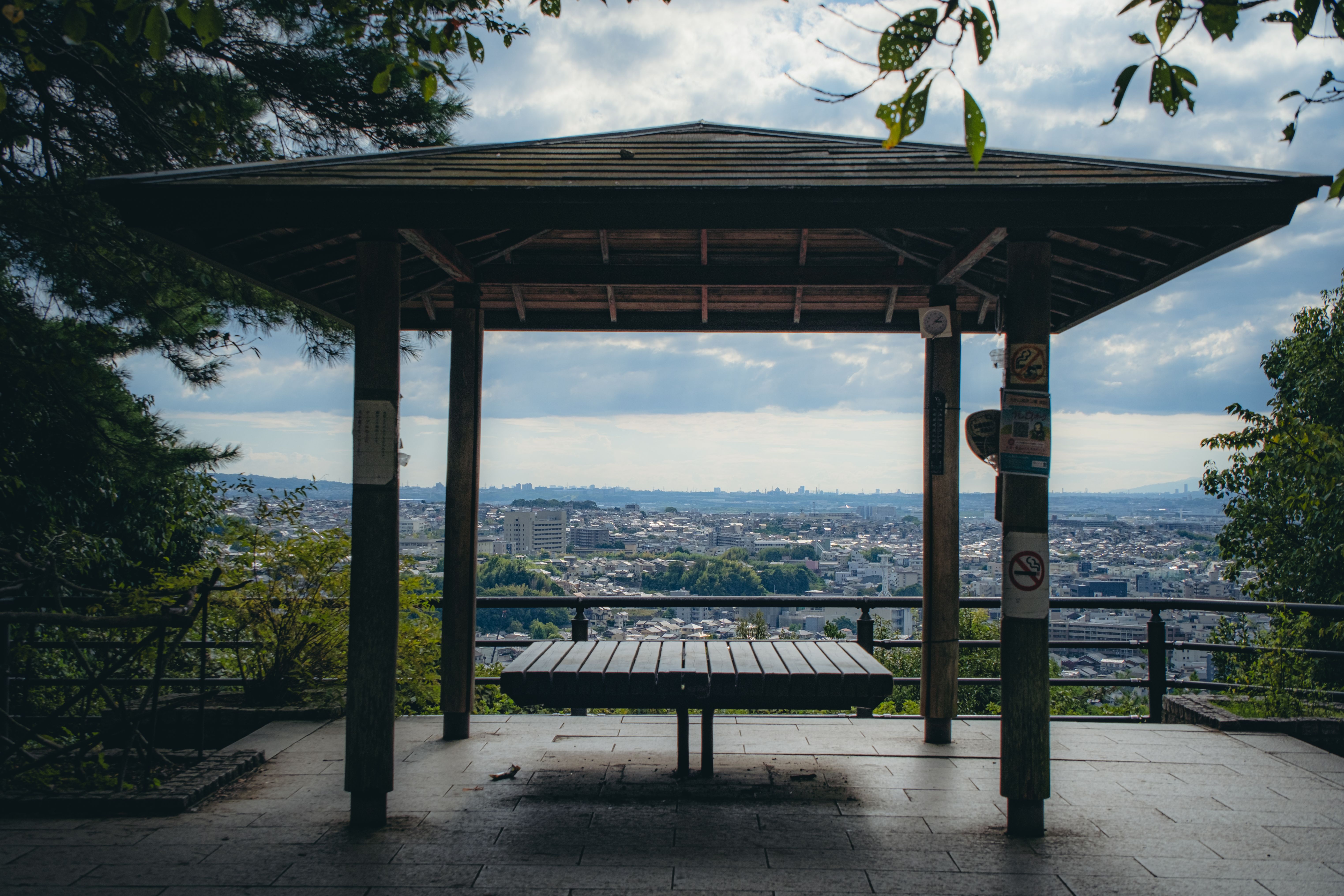Scenic Urban Overlook from a Wooden Gazebo · Free Stock Photo