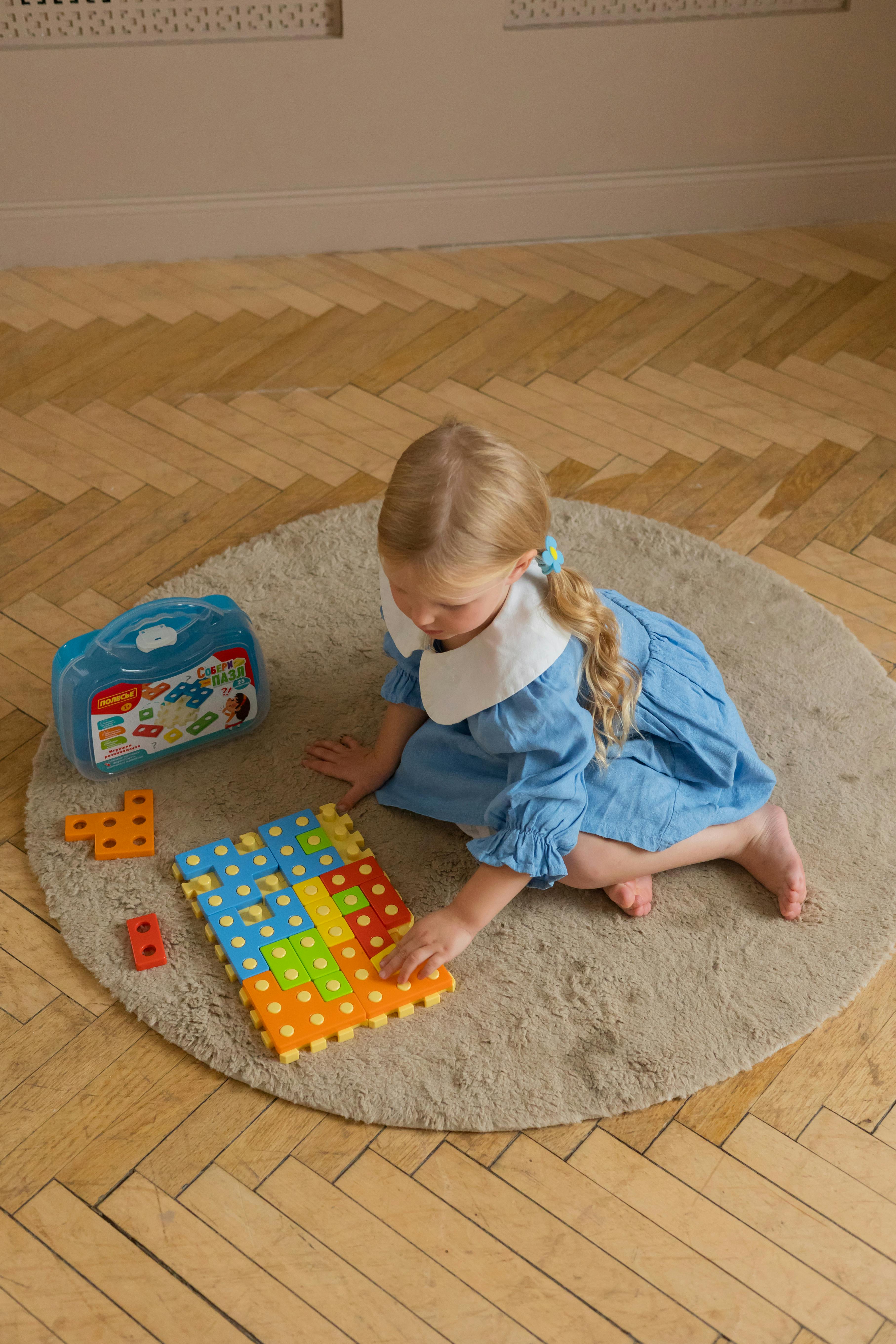 Young Girl Playing with Educational Blocks · Free Stock Photo