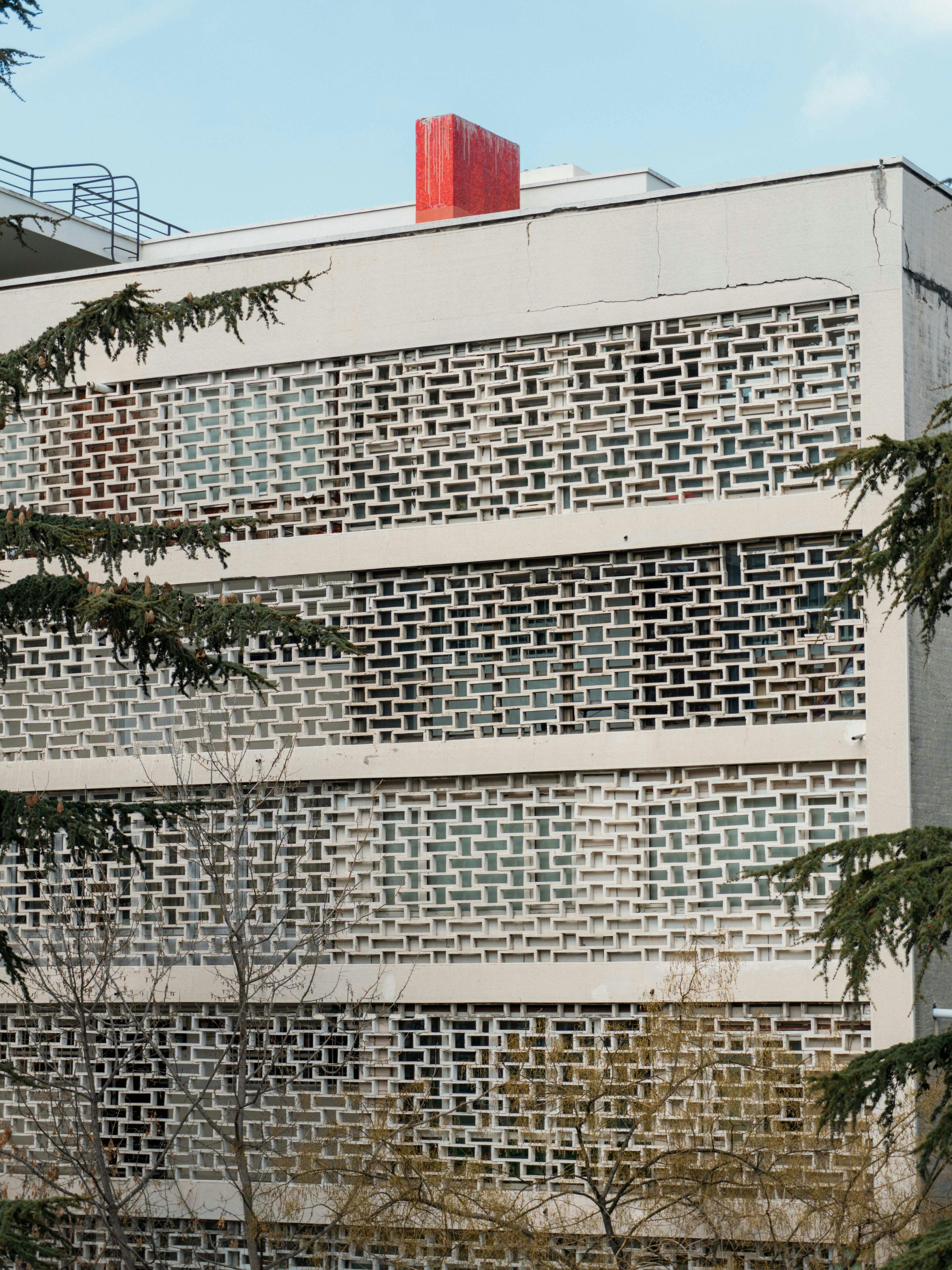Modern Concrete Building with Red Chimney · Free Stock Photo
