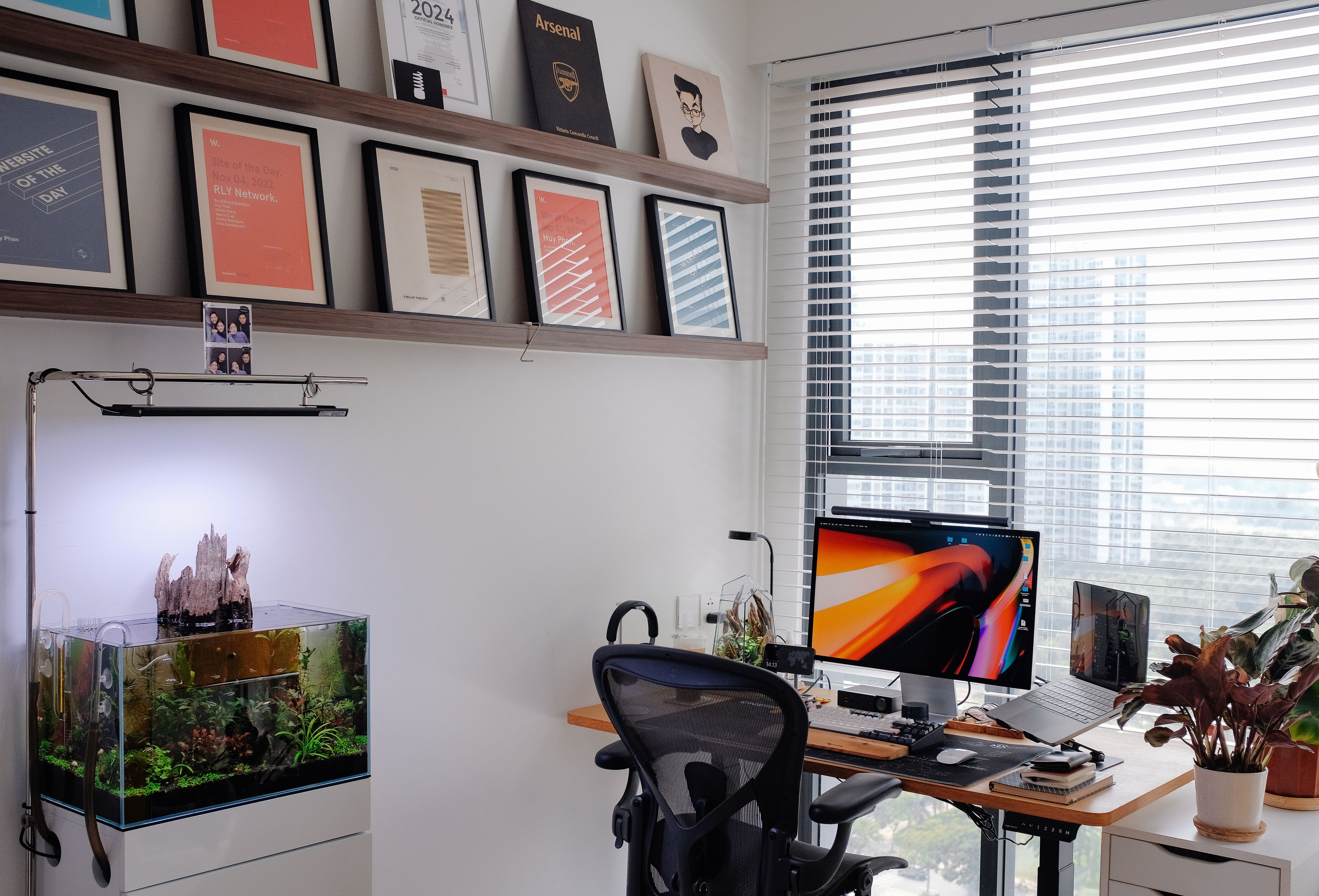Modern Workspace with Aquarium and Tech Gadgets · Free Stock Photo