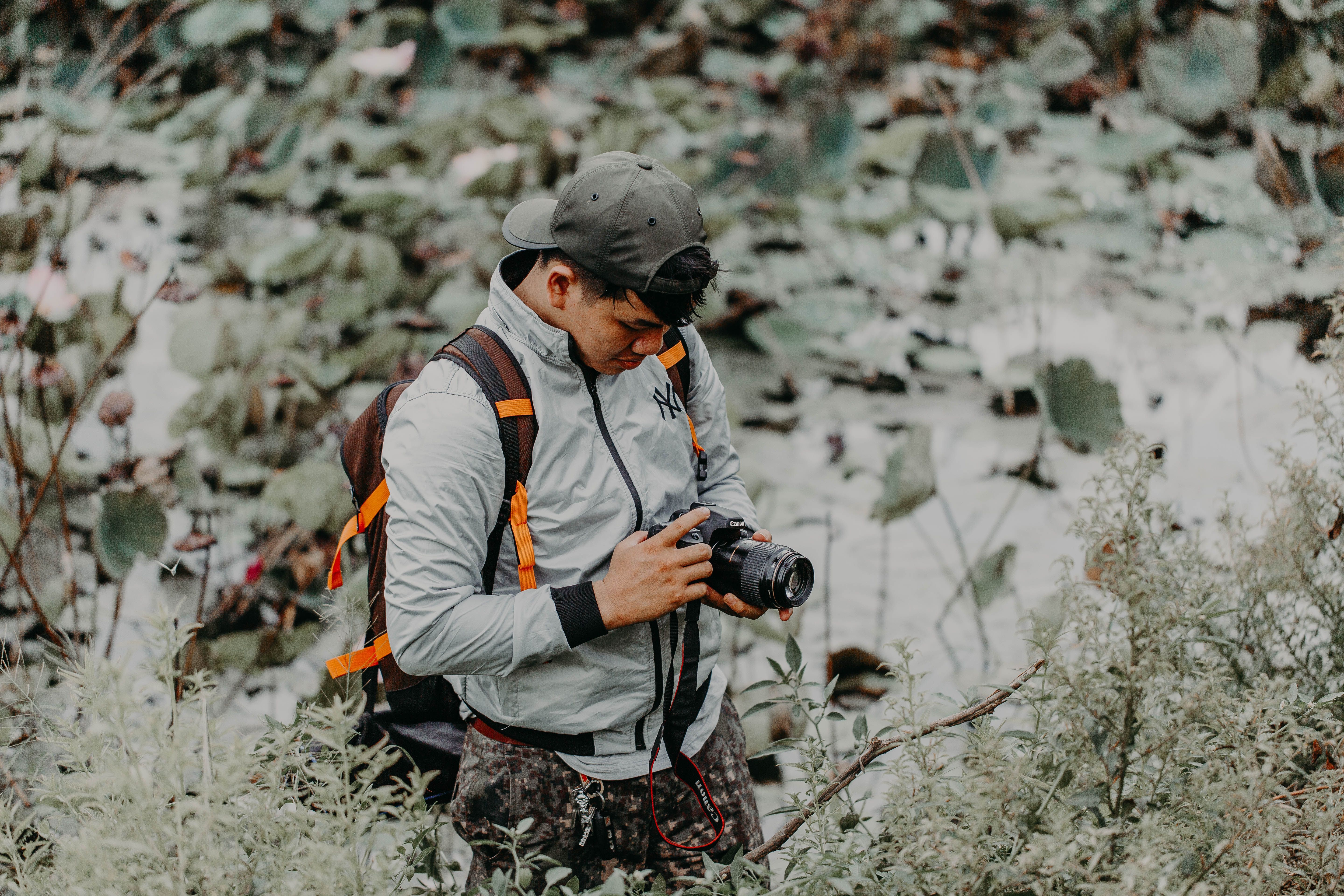 Photographer Exploring Scenic Wetland Area · Free Stock Photo