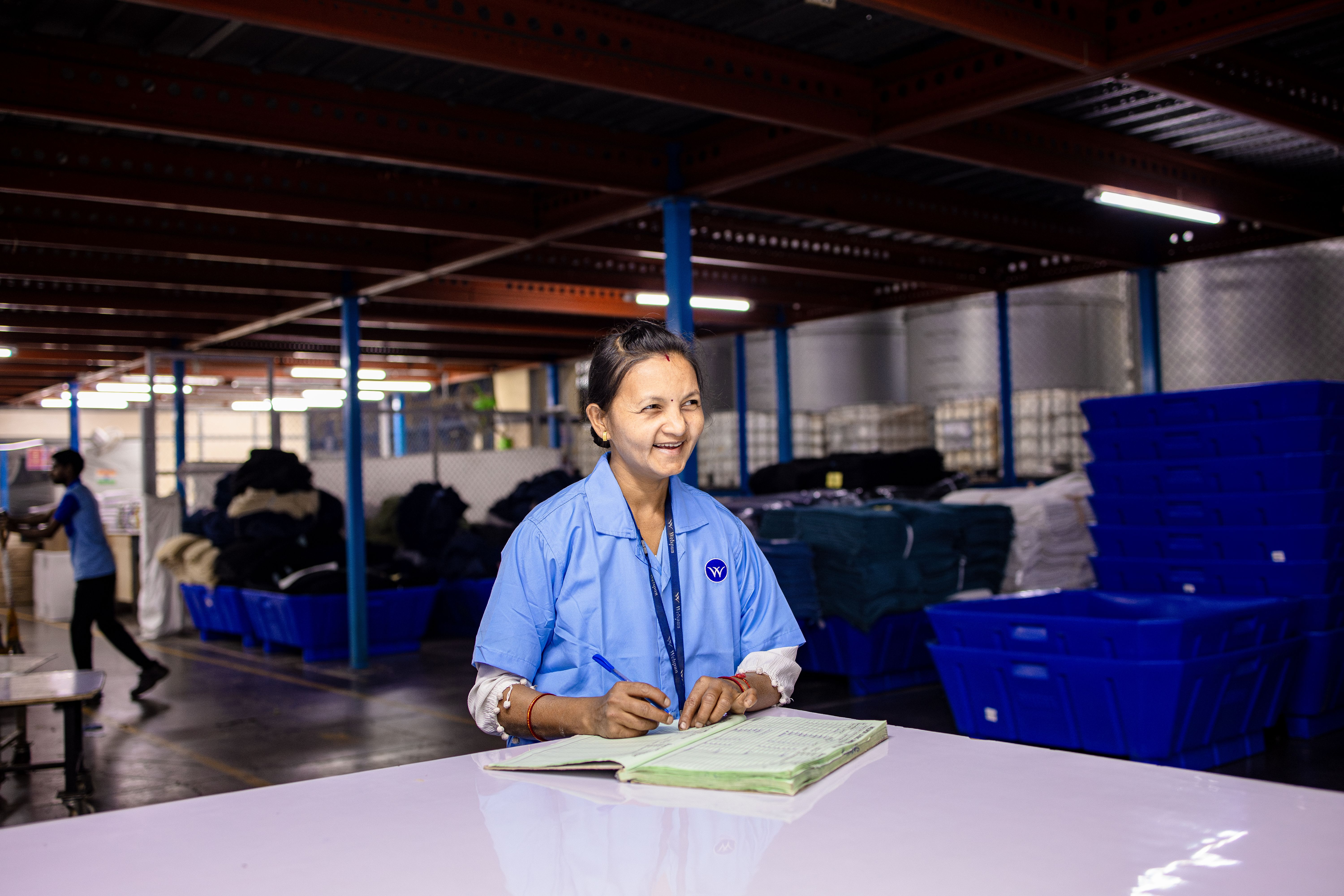 Smiling Woman in Blue Uniform at Textile Factory · Free Stock Photo