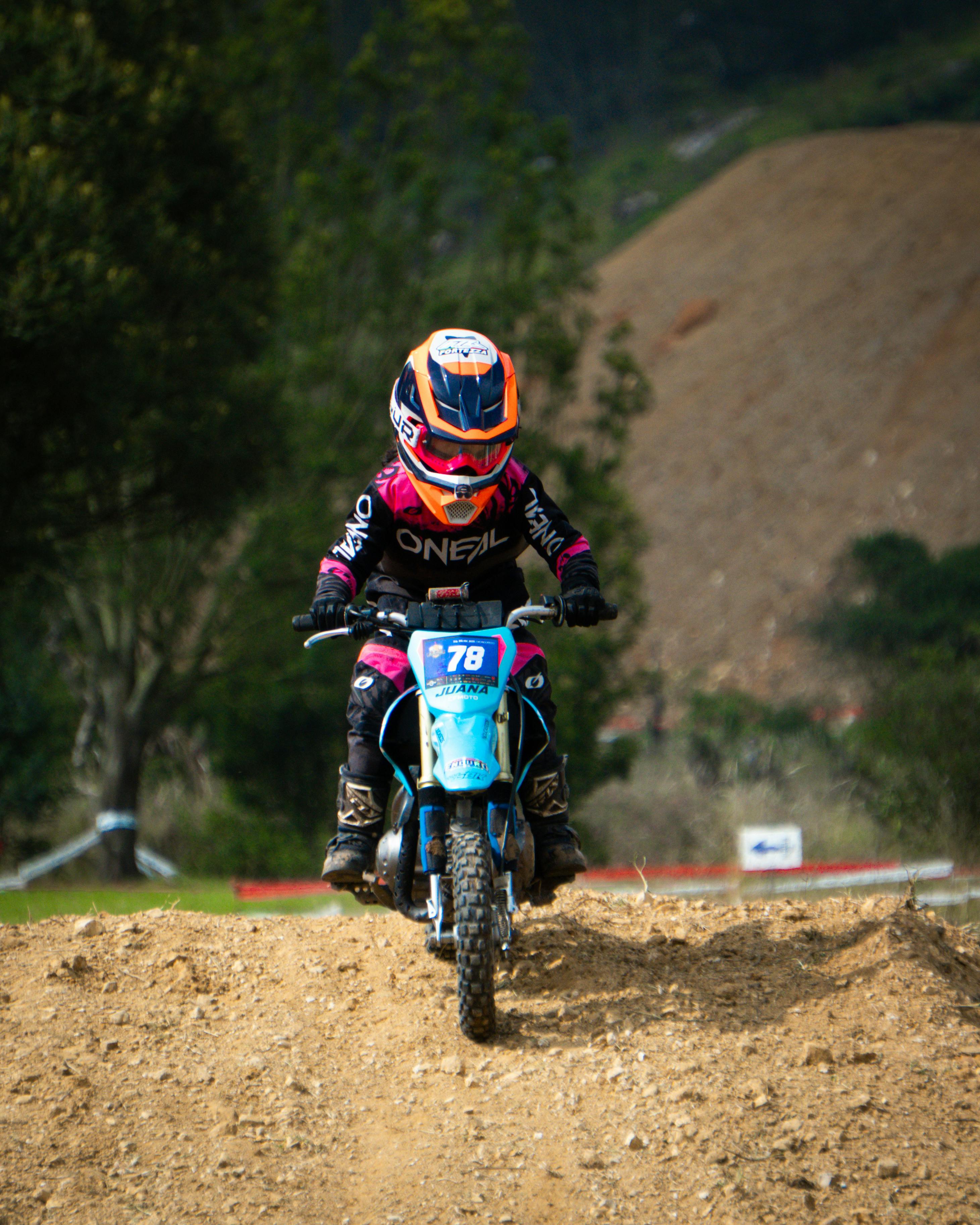 Young Motocross Rider Racing on Dirt Track · Free Stock Photo
